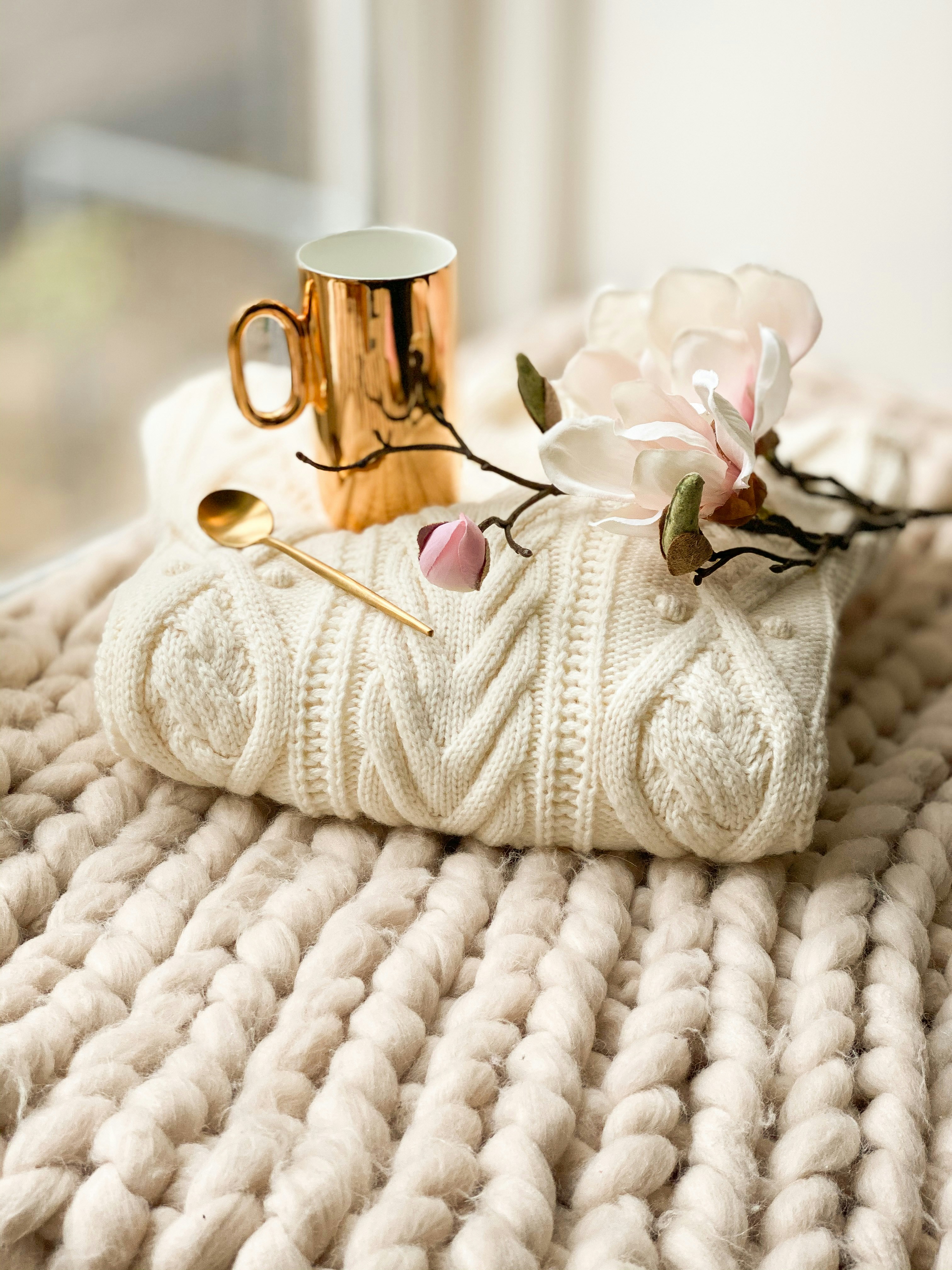 Golden Cup on Cozy Knit: Quiet Still Life with Magnolia