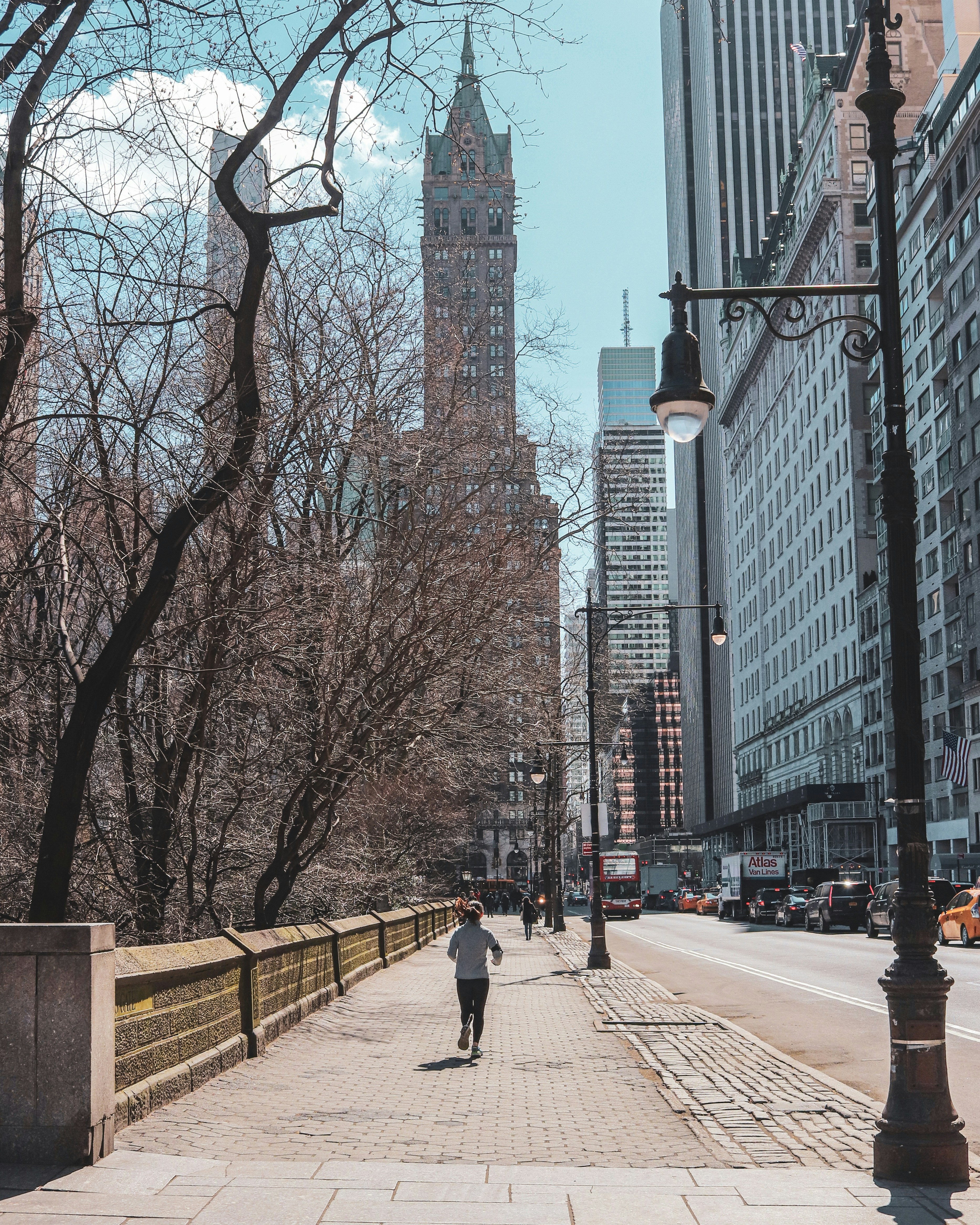 People walking on sidewalk near high rise buildings during daytime ...