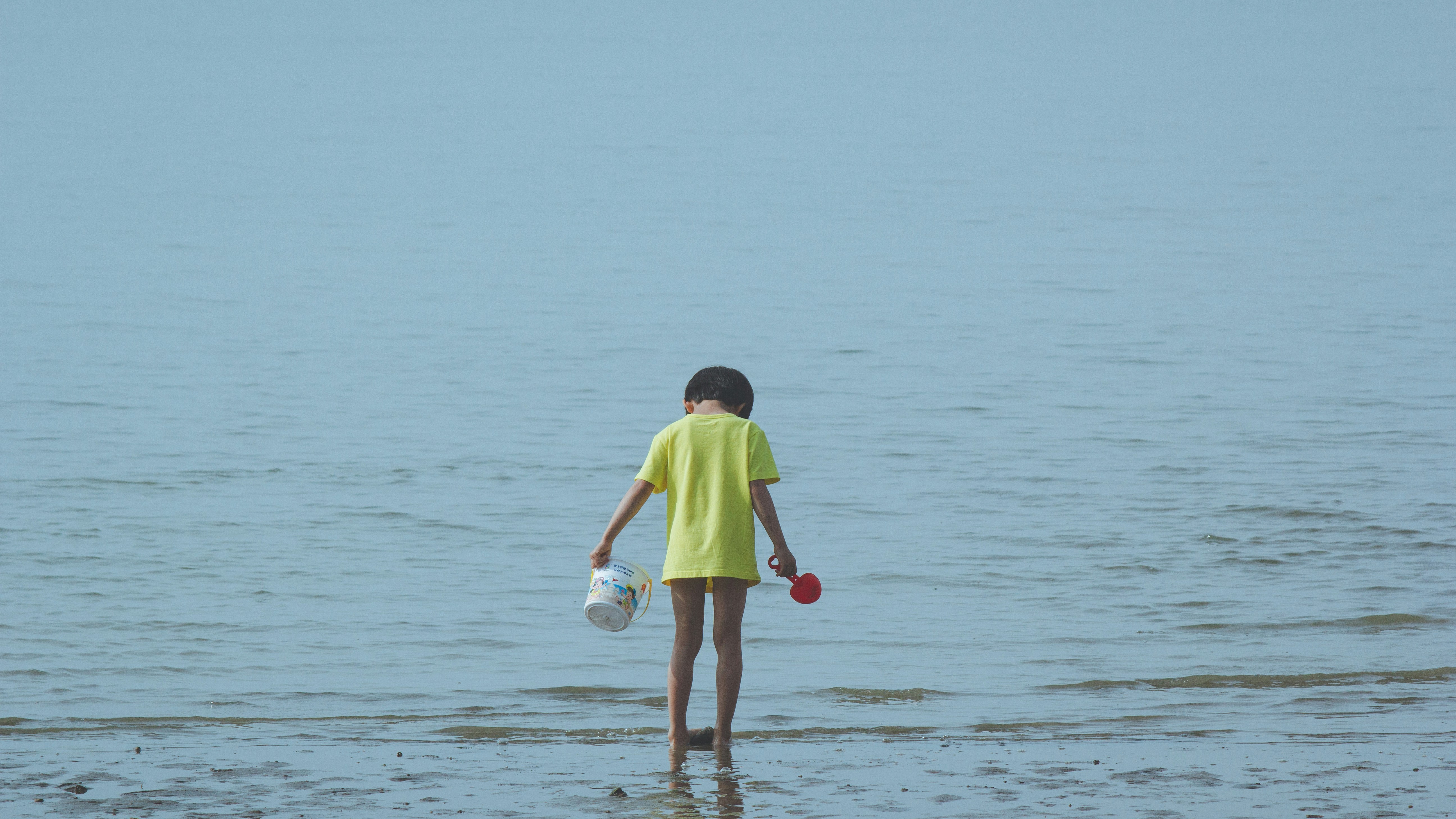 Boy in yellow shirt playing on water during daytime photo – Free Sea ...
