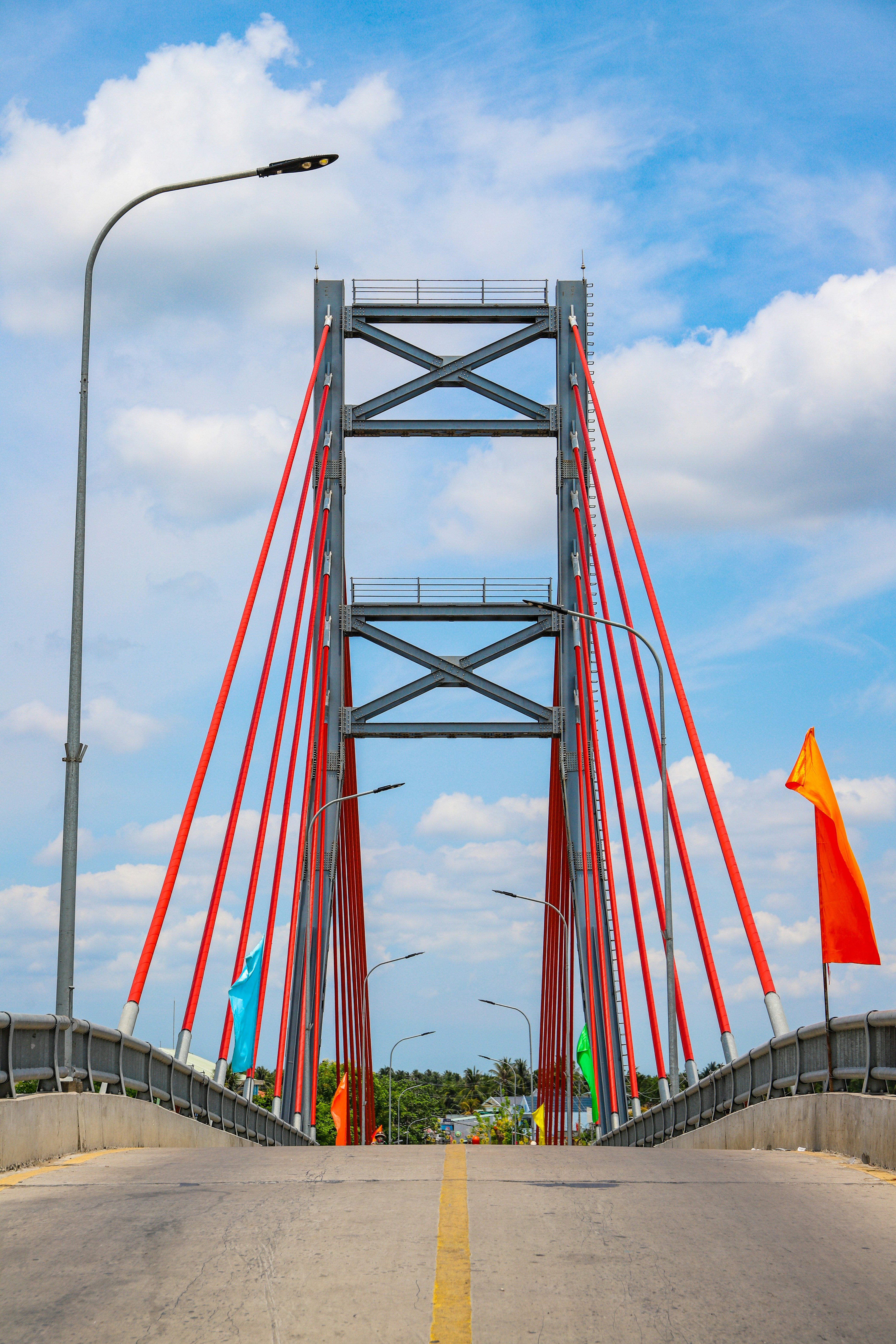 Crimson Cables Framing the Skyward Gate of a Modern Suspension Bridge