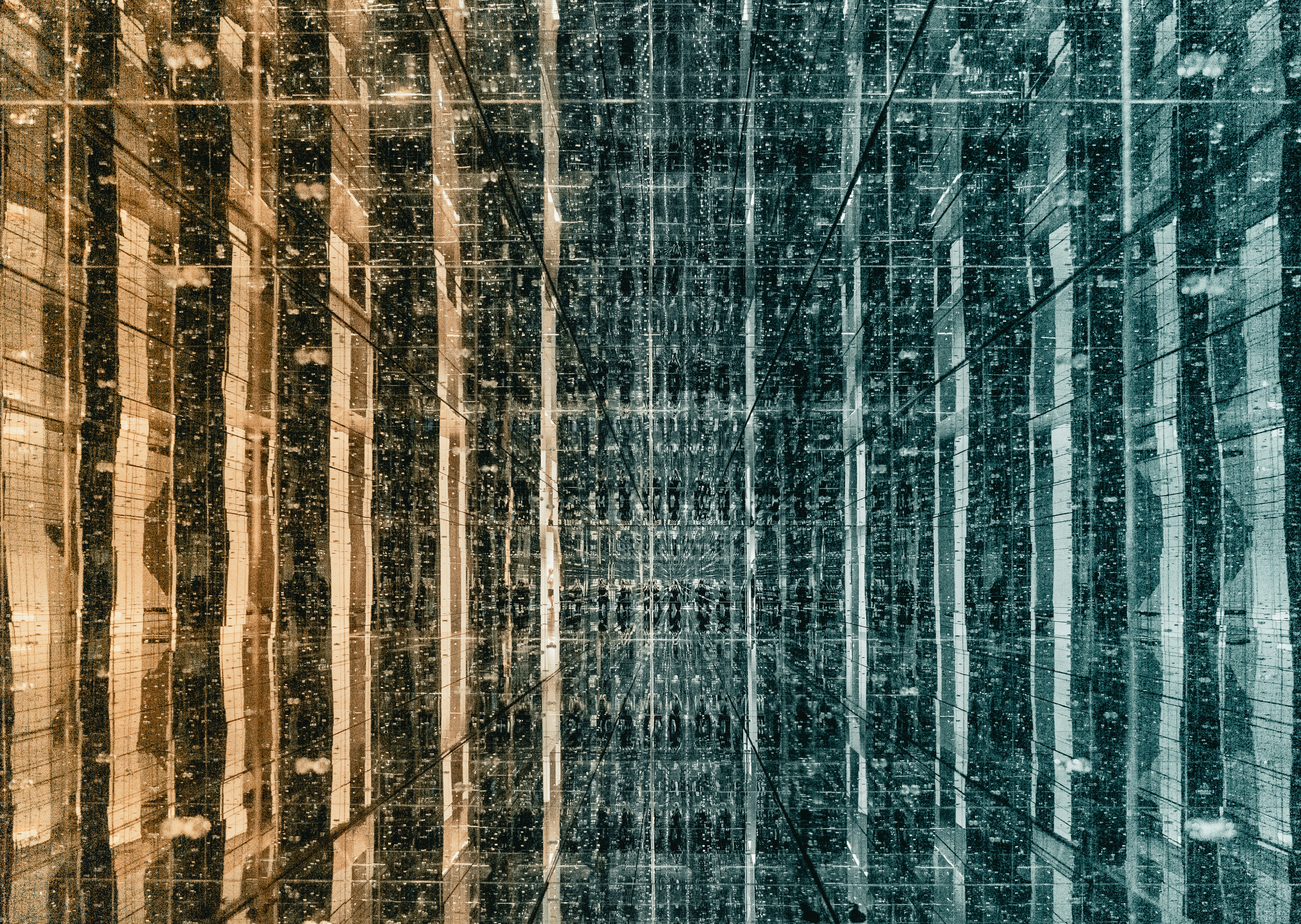 Symmetrical reflections of warm and cool-toned lights in a mirrored exhibit.