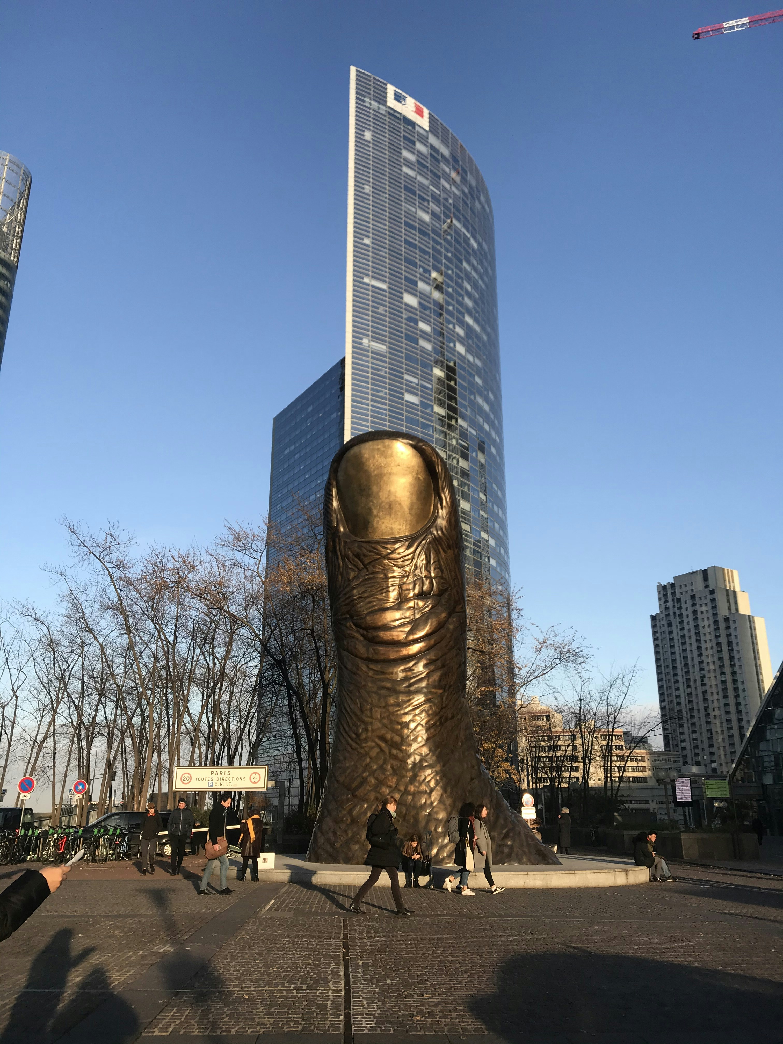 People sitting on bench near high rise building during daytime photo ...