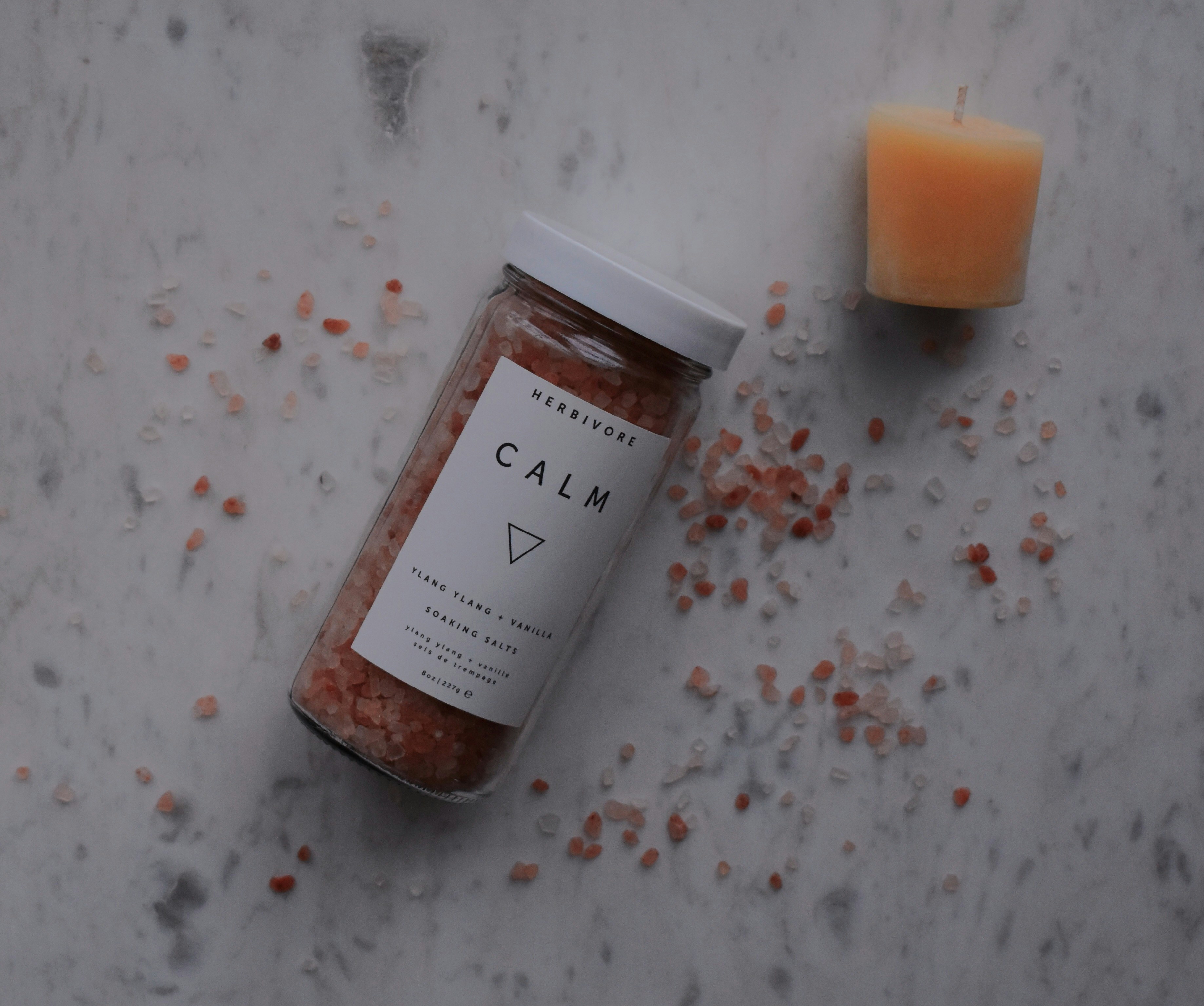 Calm Vial: A Salt Rock Jar Poised Between Marble and Candlelight