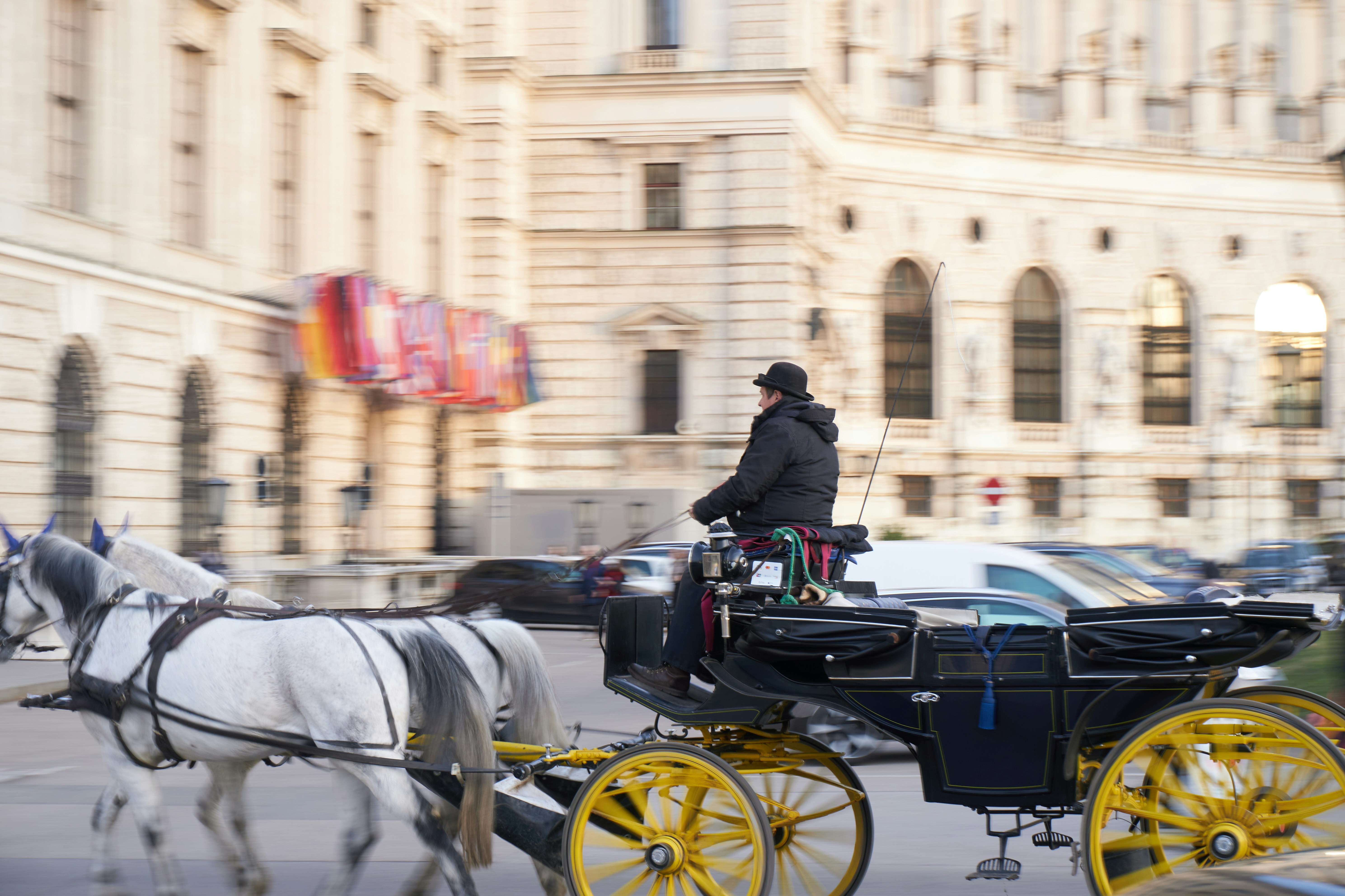 Gilded Wheels and White Horses on a European Boulevard