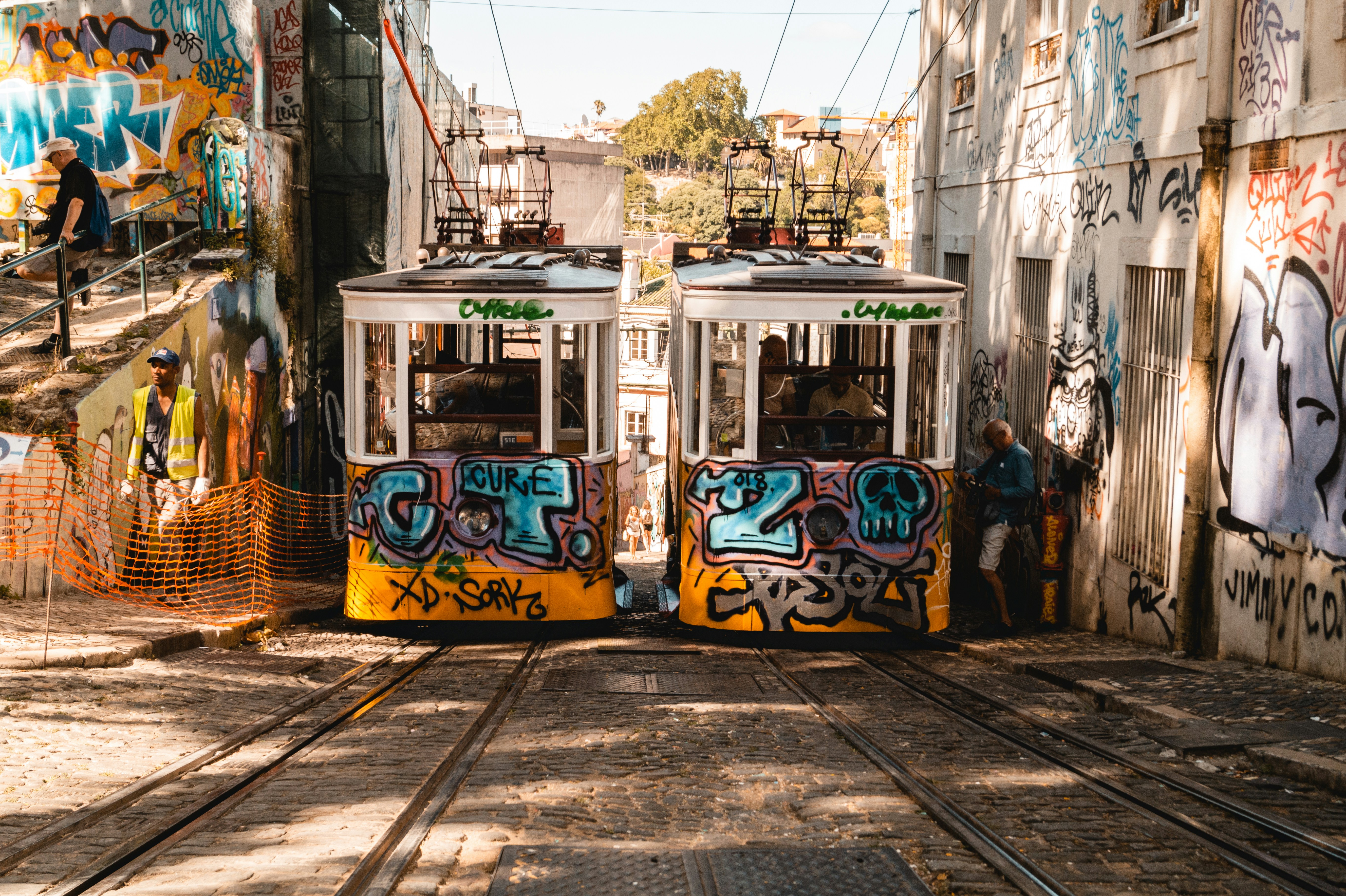 Twin Graffiti Trams Framed by Urban Light