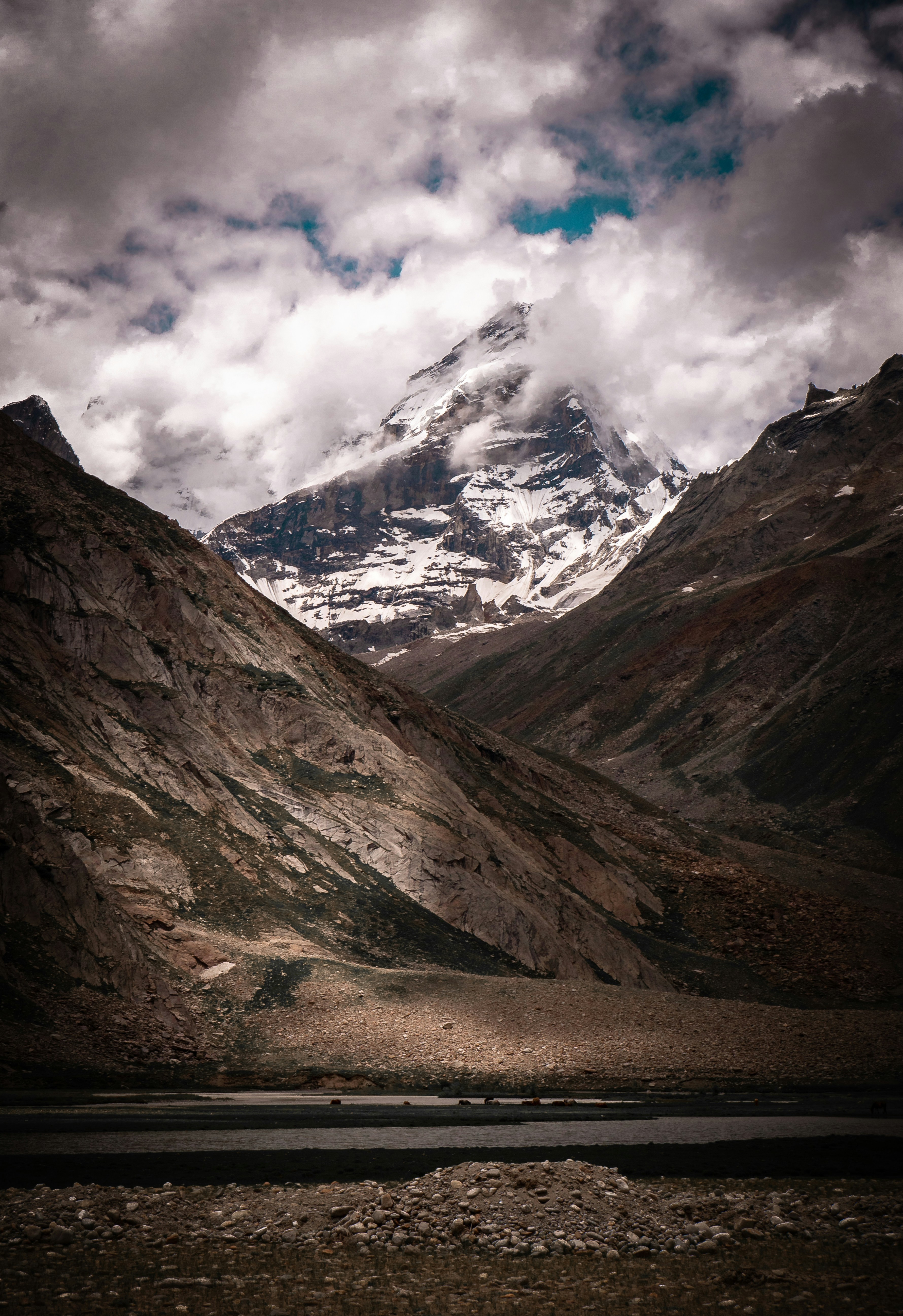 Brown and gray mountains under white clouds and blue sky during daytime ...