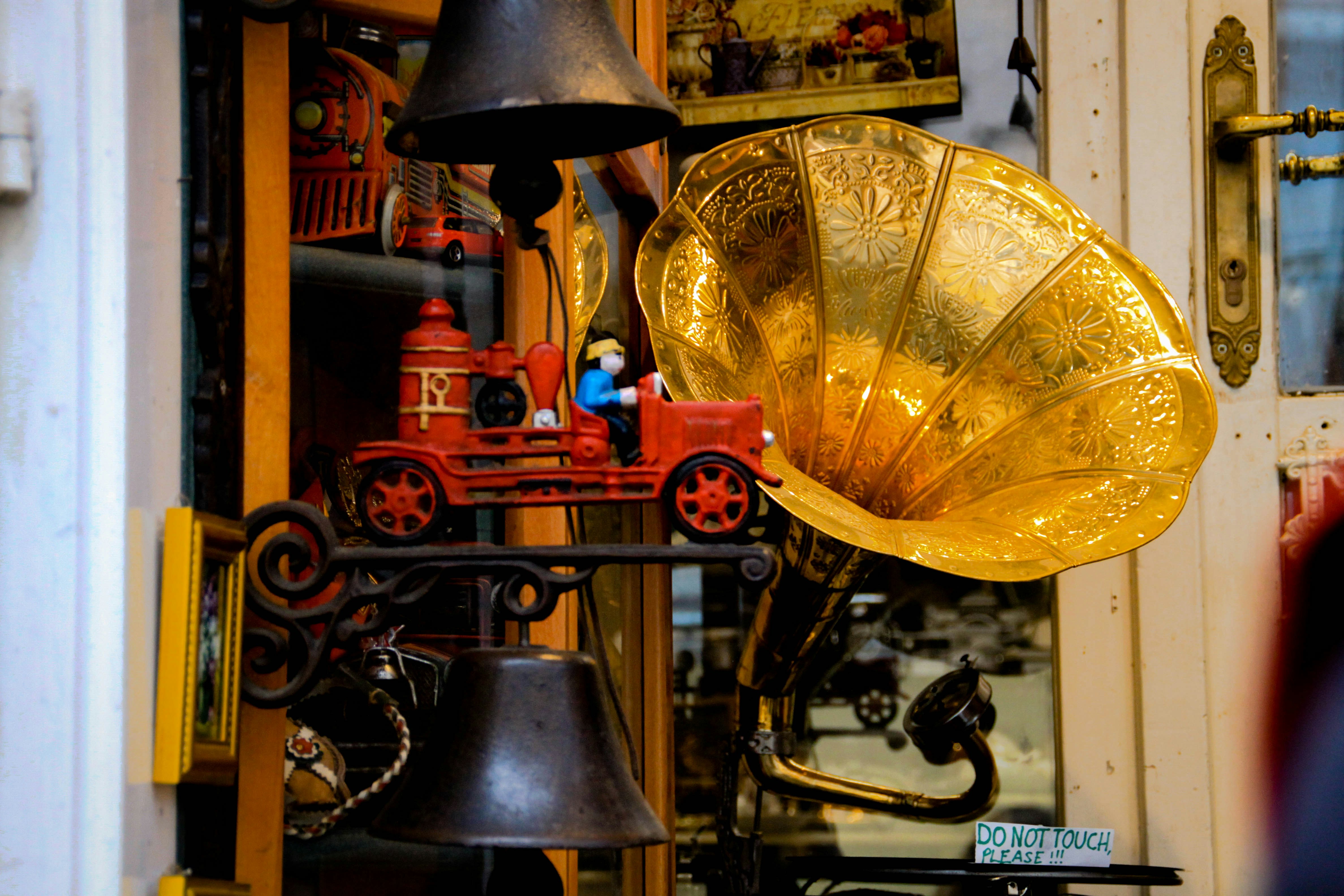Gilded Gramophone and a Toy Fire Truck in a Curious Shopfront
