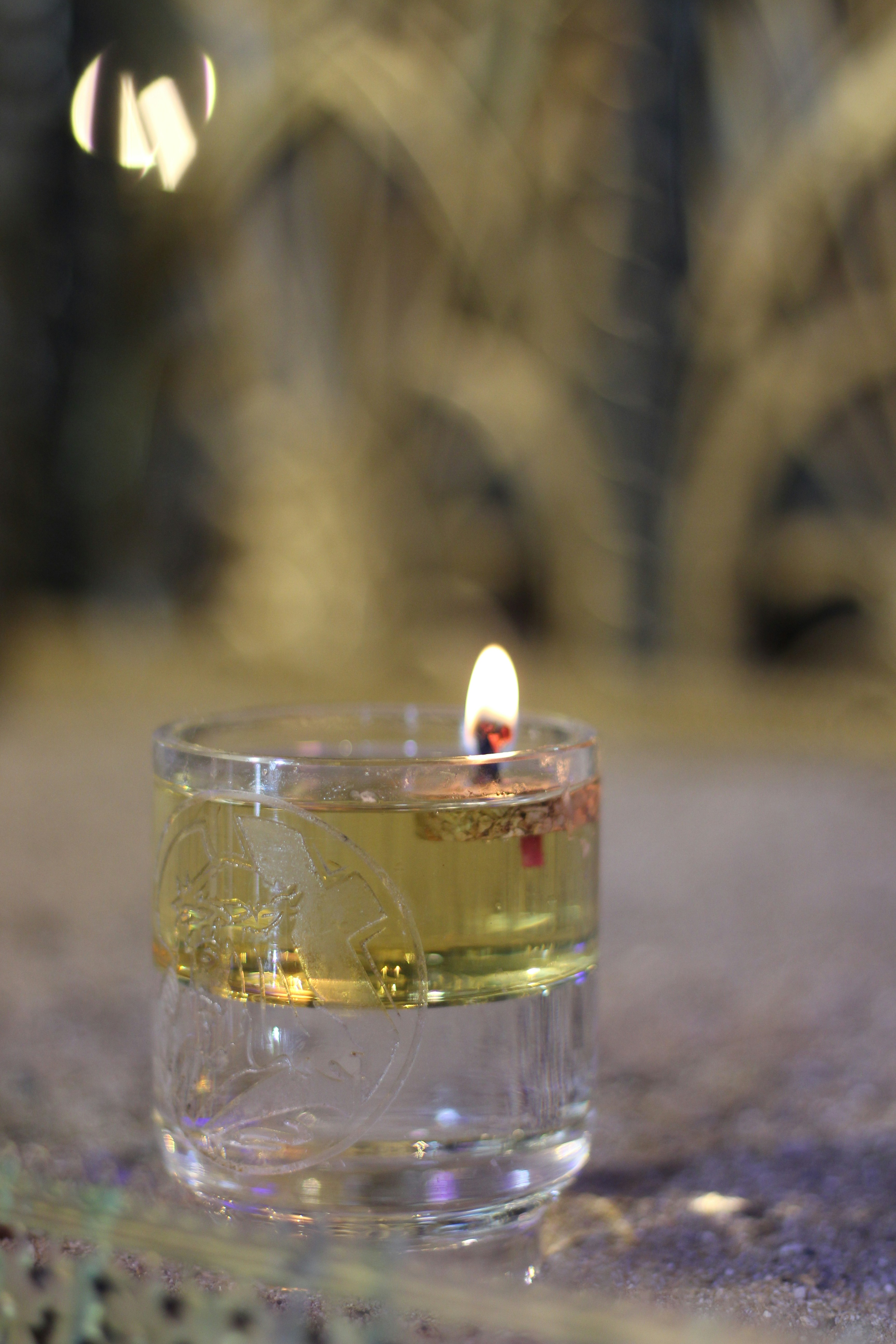 lighted candle in clear glass