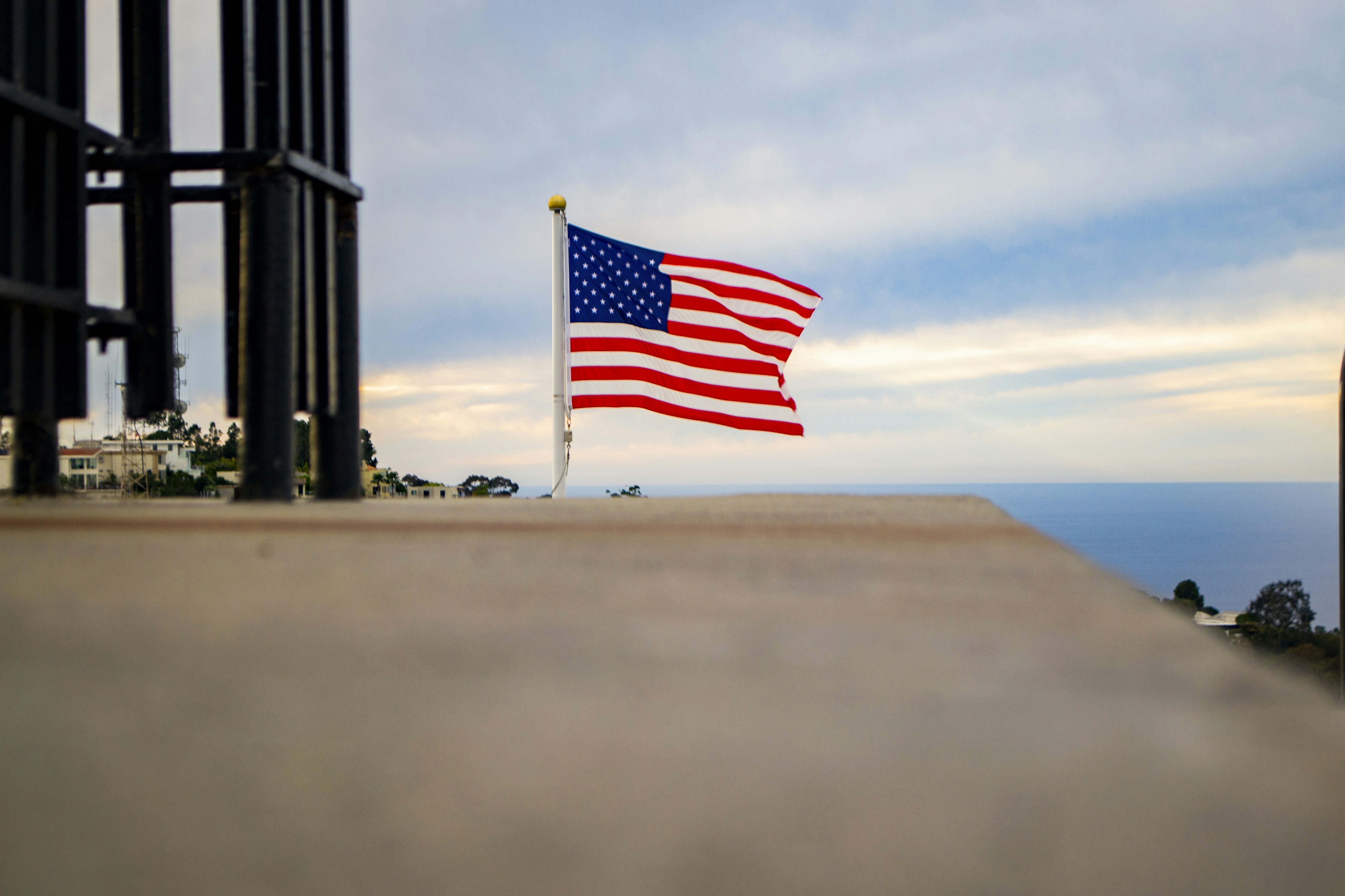 Flag at the Edge: Wind-Woven Banner Against a Calm Horizon