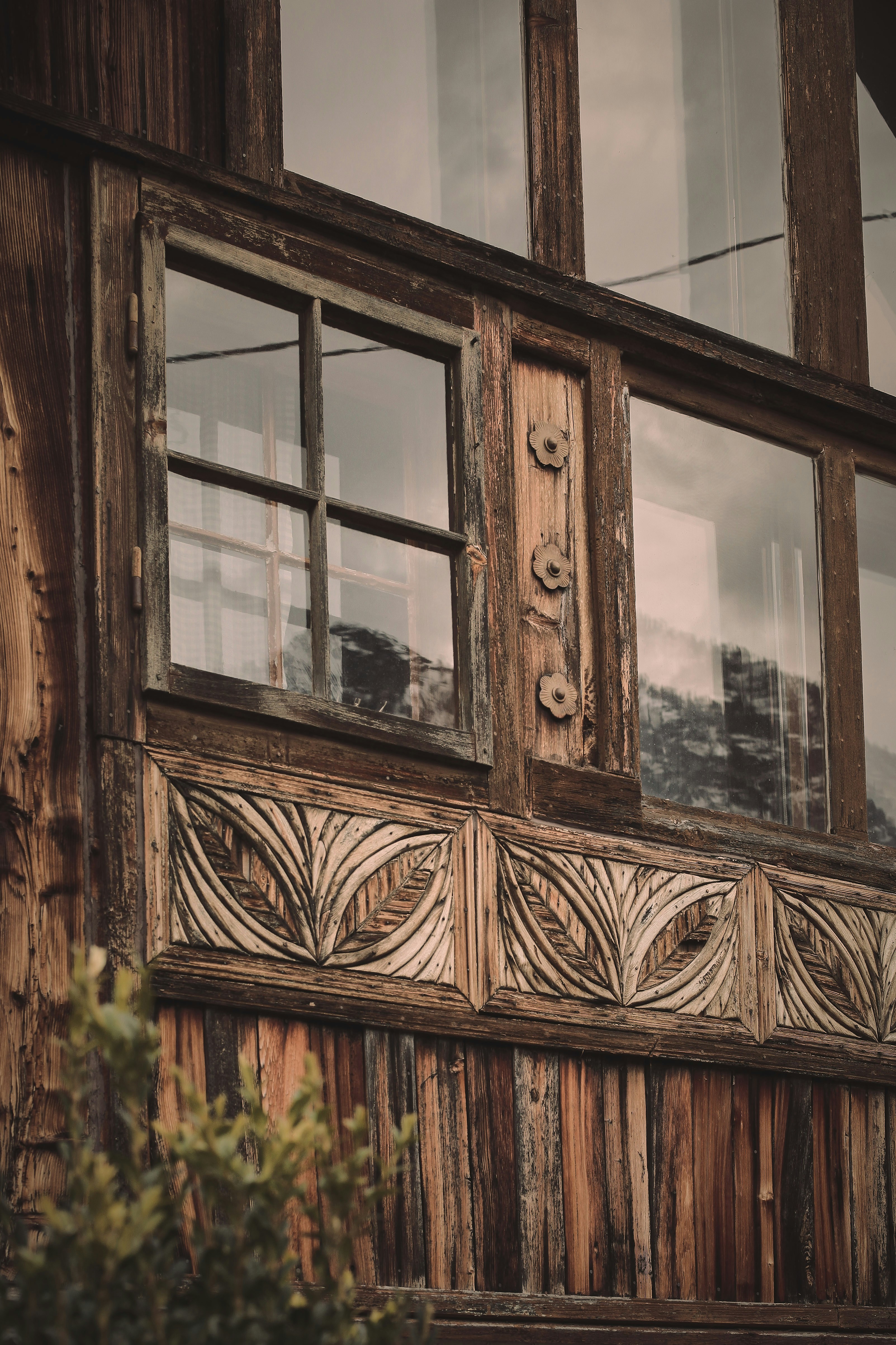 Echoes of Craft: Carved Timber Facade Framed by Glass