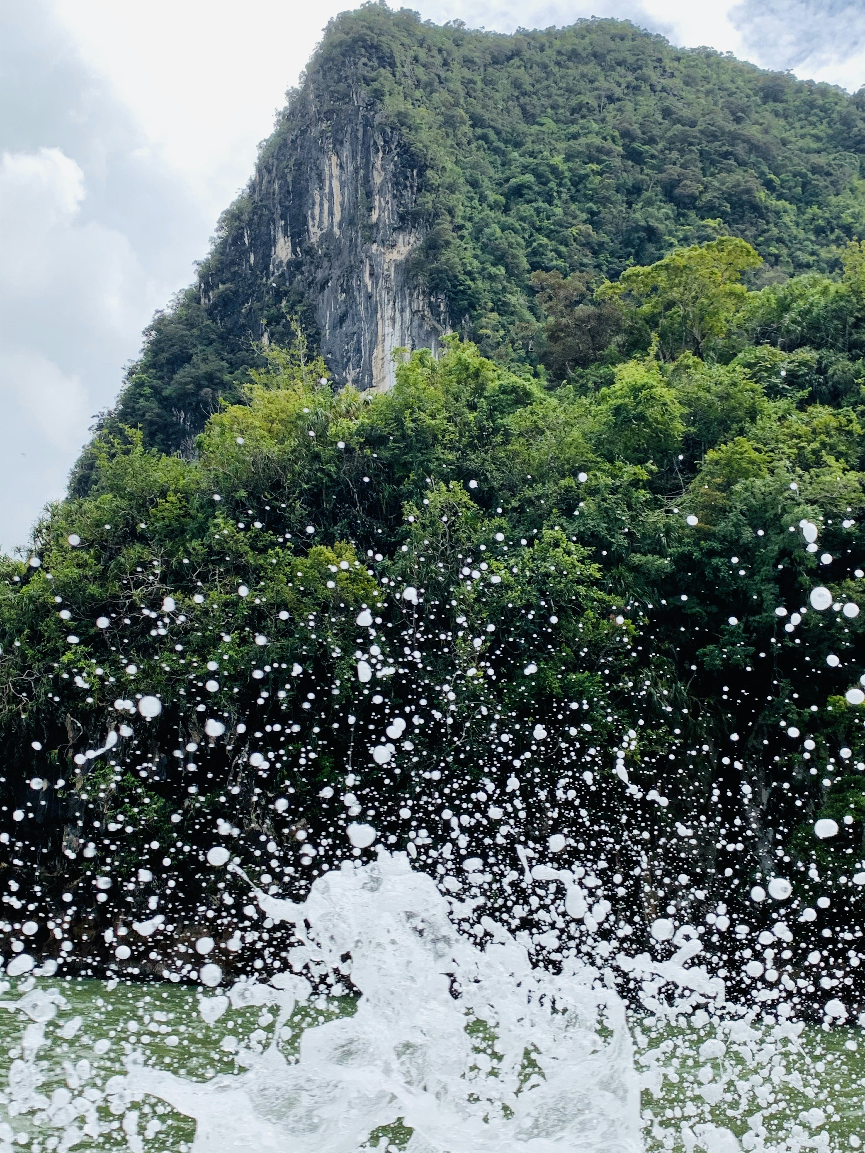 a man riding a surfboard on top of a wave