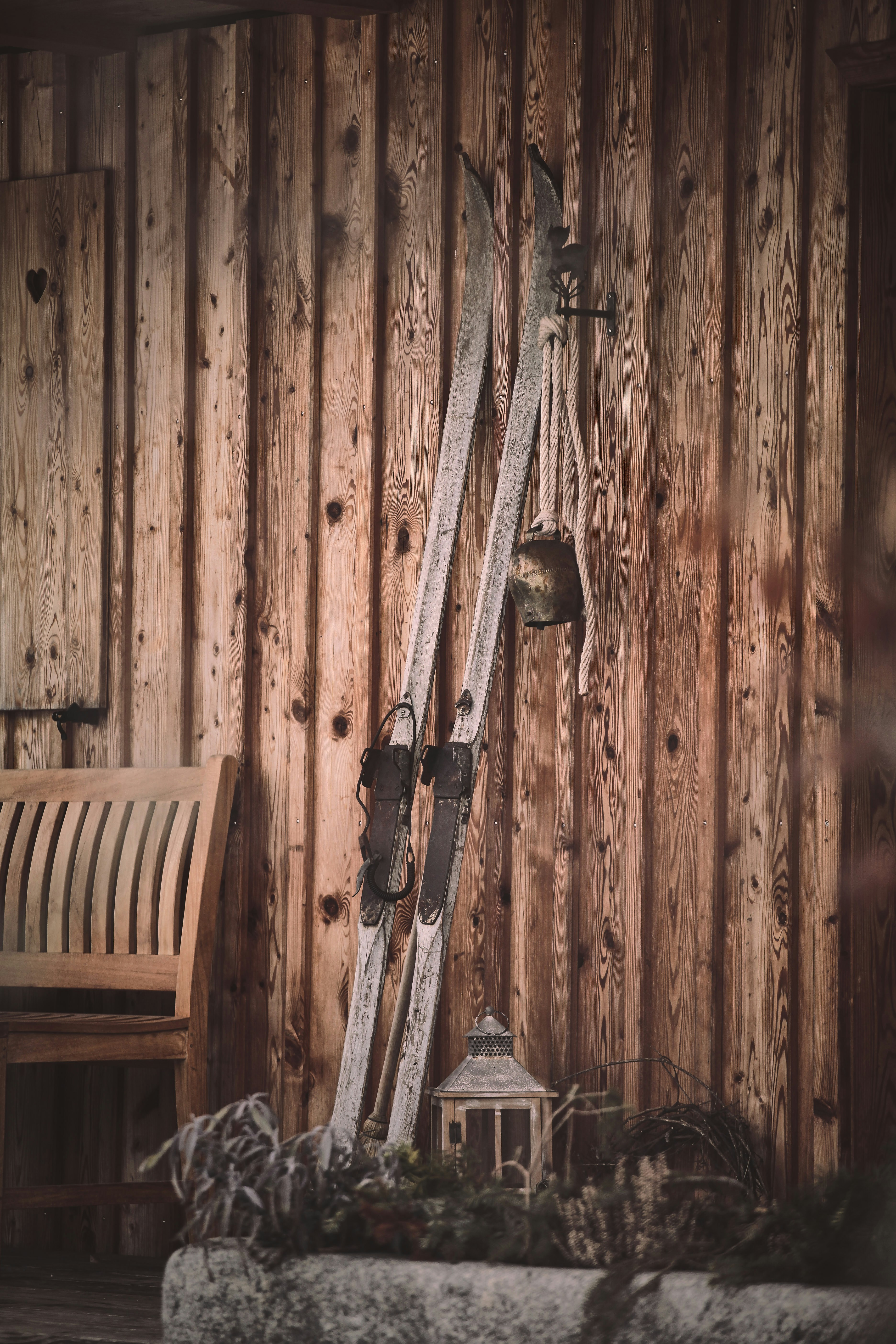 Rustic Vintage: Skis Leaning Against a Cabin Wall