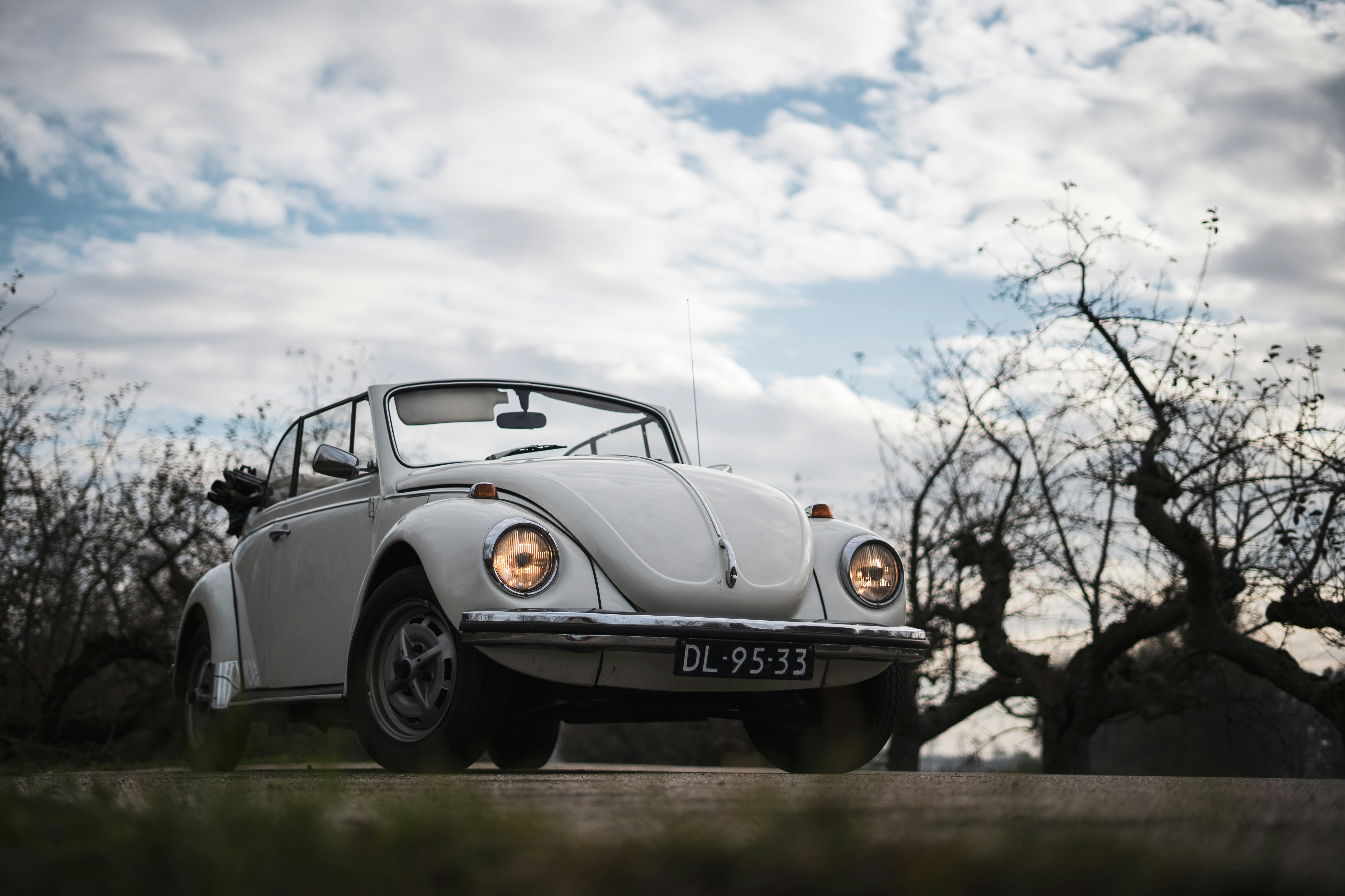 White convertible car on green grass field under white clouds during ...