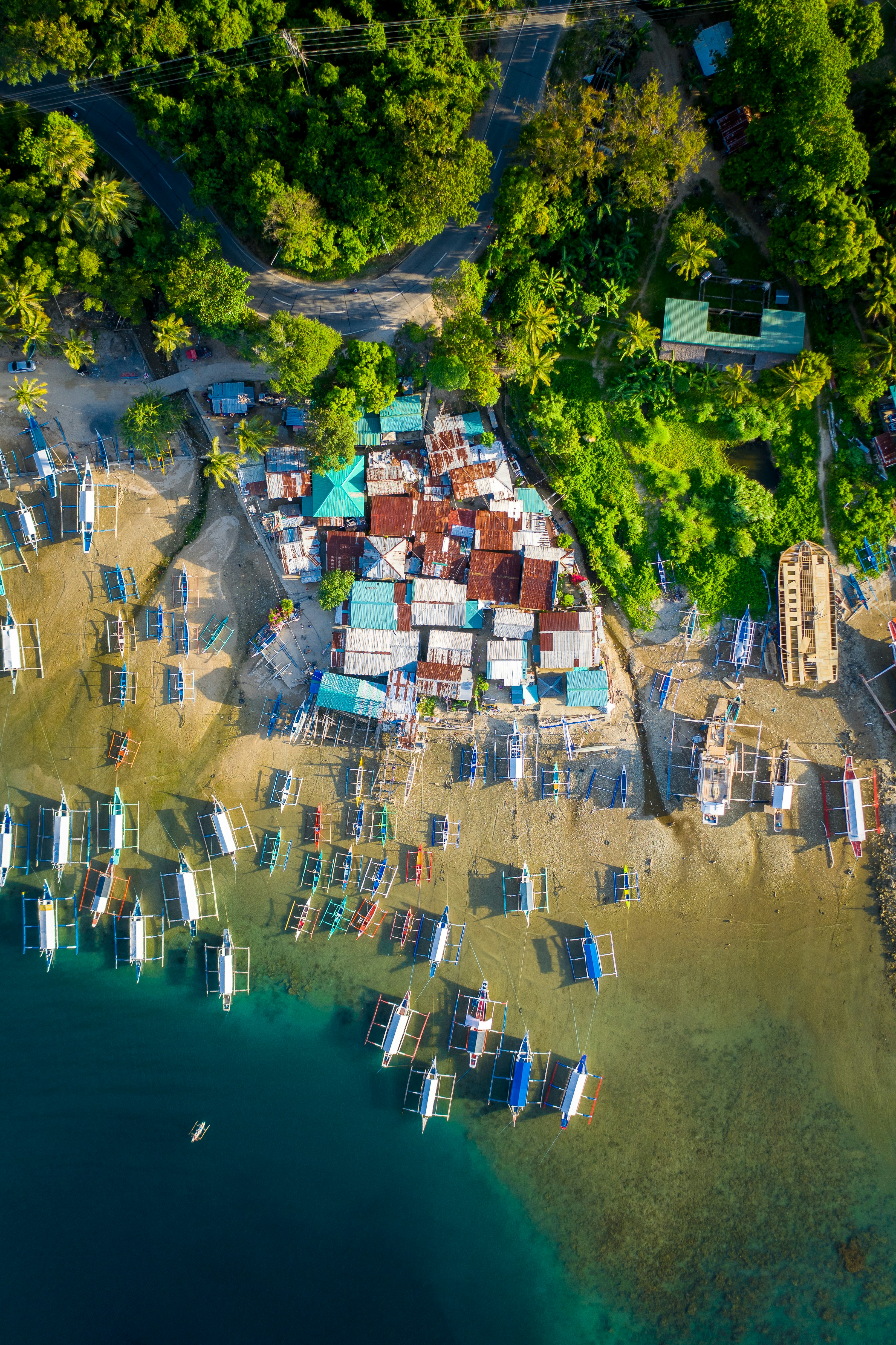 Colorful Roofscape by the Turquoise Shore: An Aerial Portrait of a Coastal Hamlet