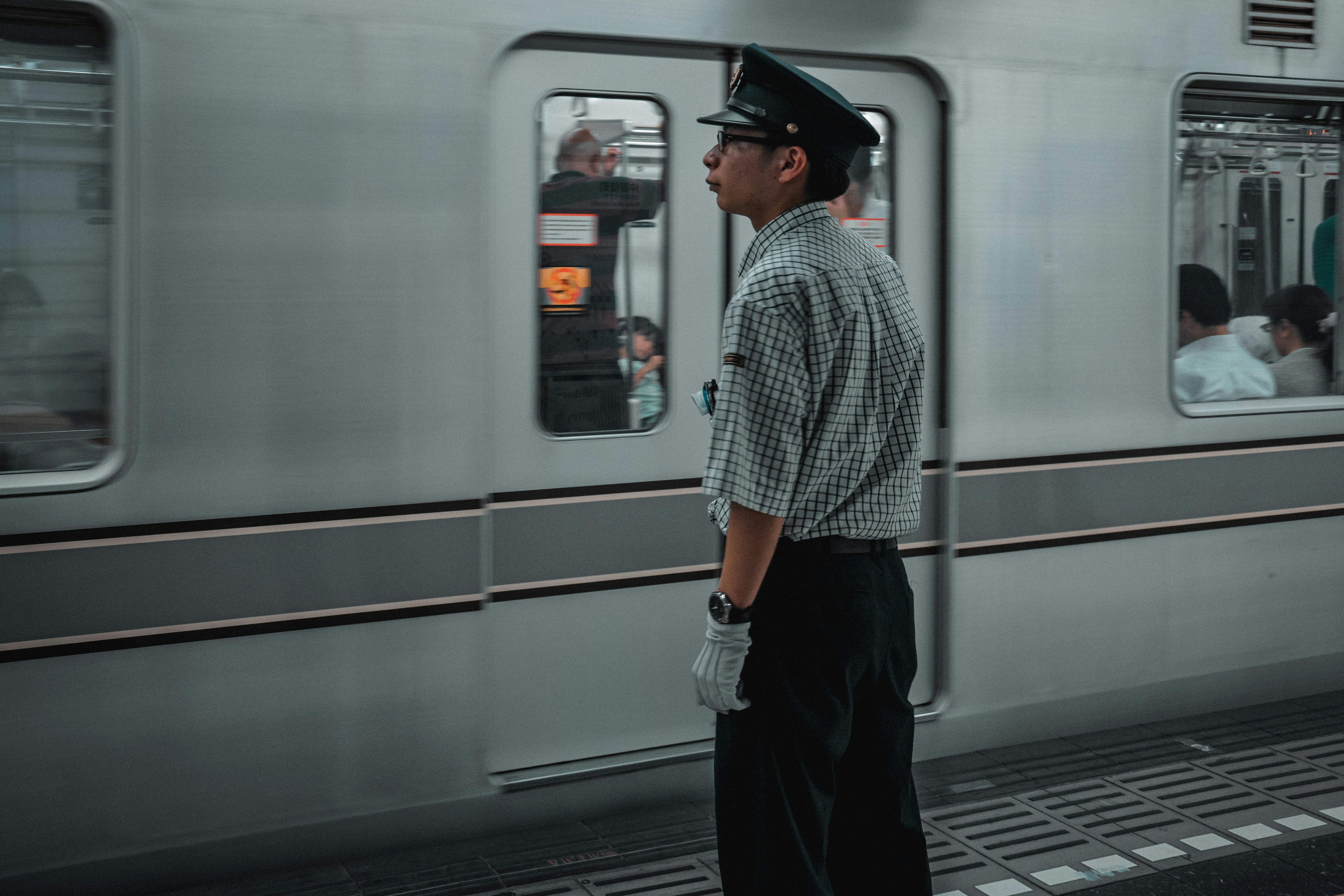 Platform Sentinel: A Transit Officer Pauses as a Subway Glides By