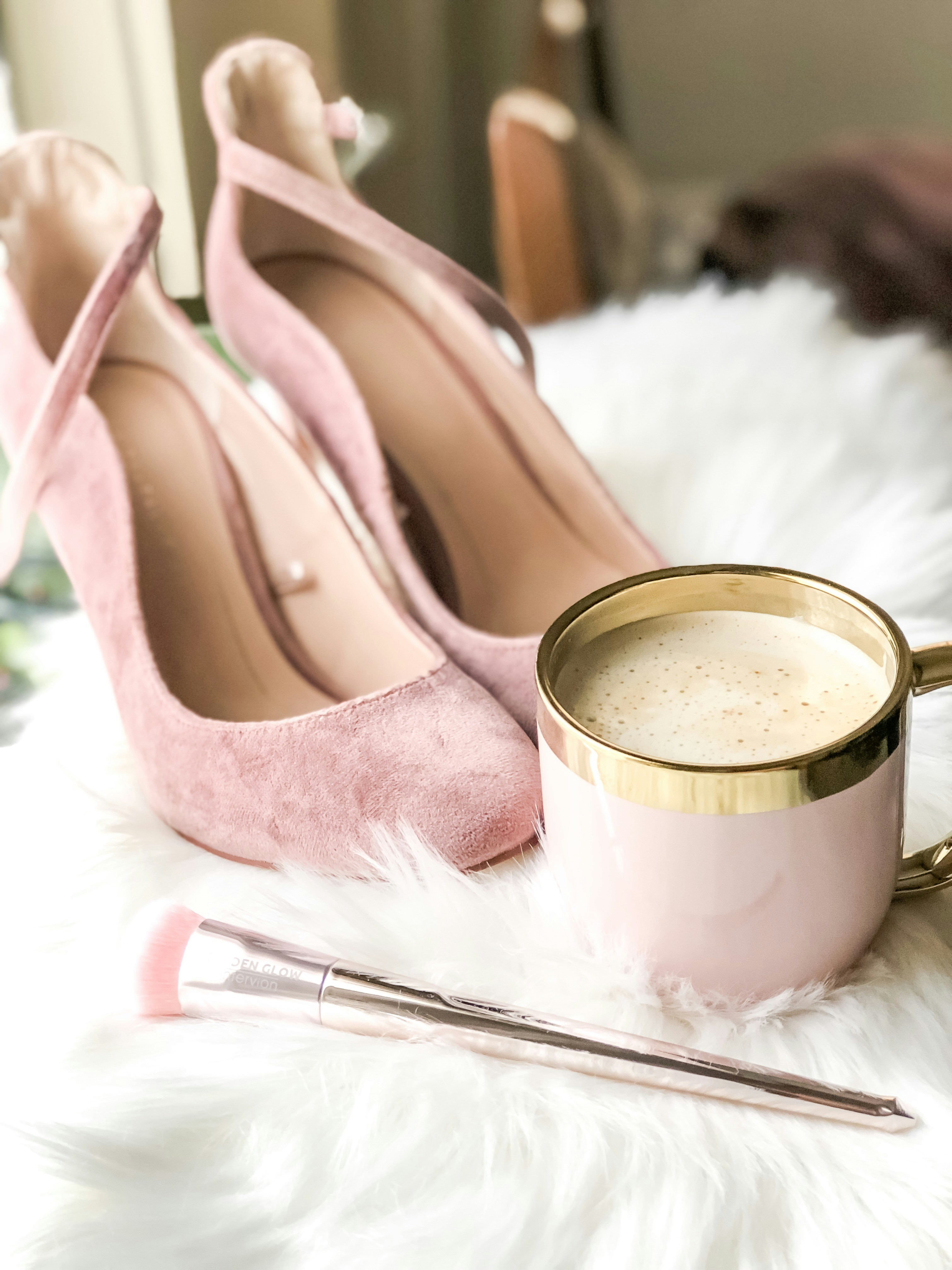 Pastel Suede Heels Beside a Gold-Rimmed Latte Mug on Plush White Surface