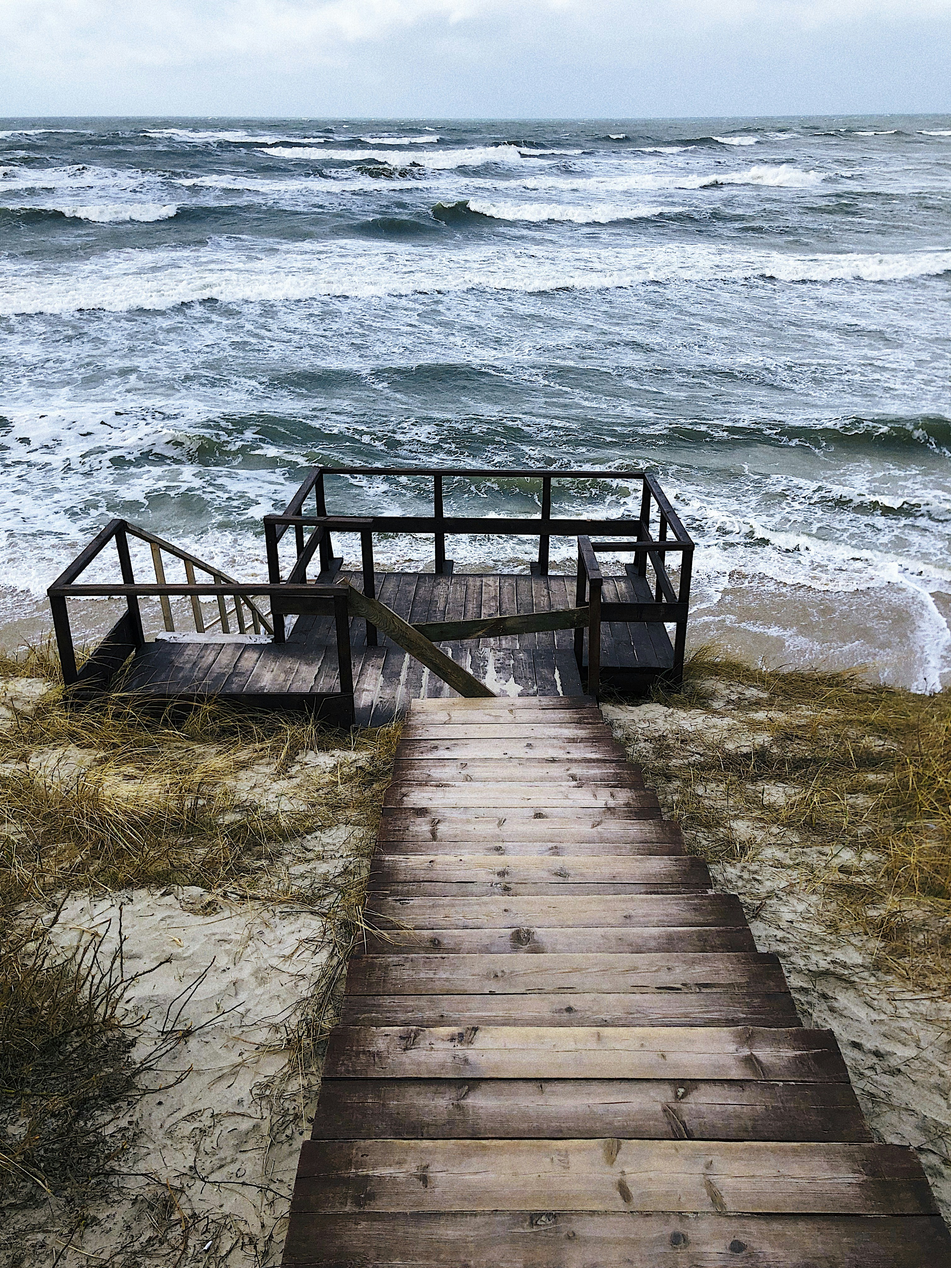 Staircase to the Sea: Weathered Deck Reaching the Churning Horizon
