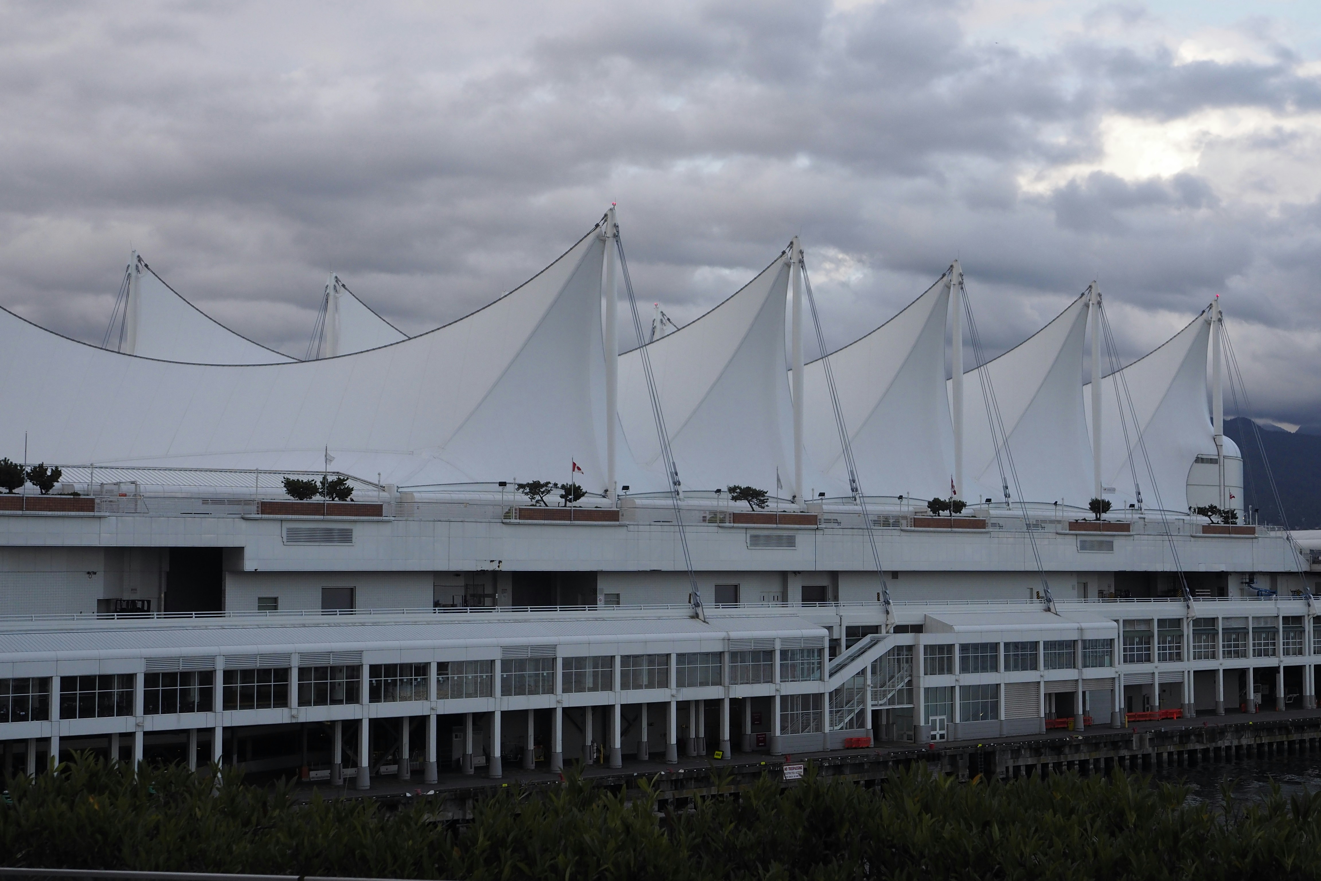 Sail-Topped Riverside Complex under a Moody Sky