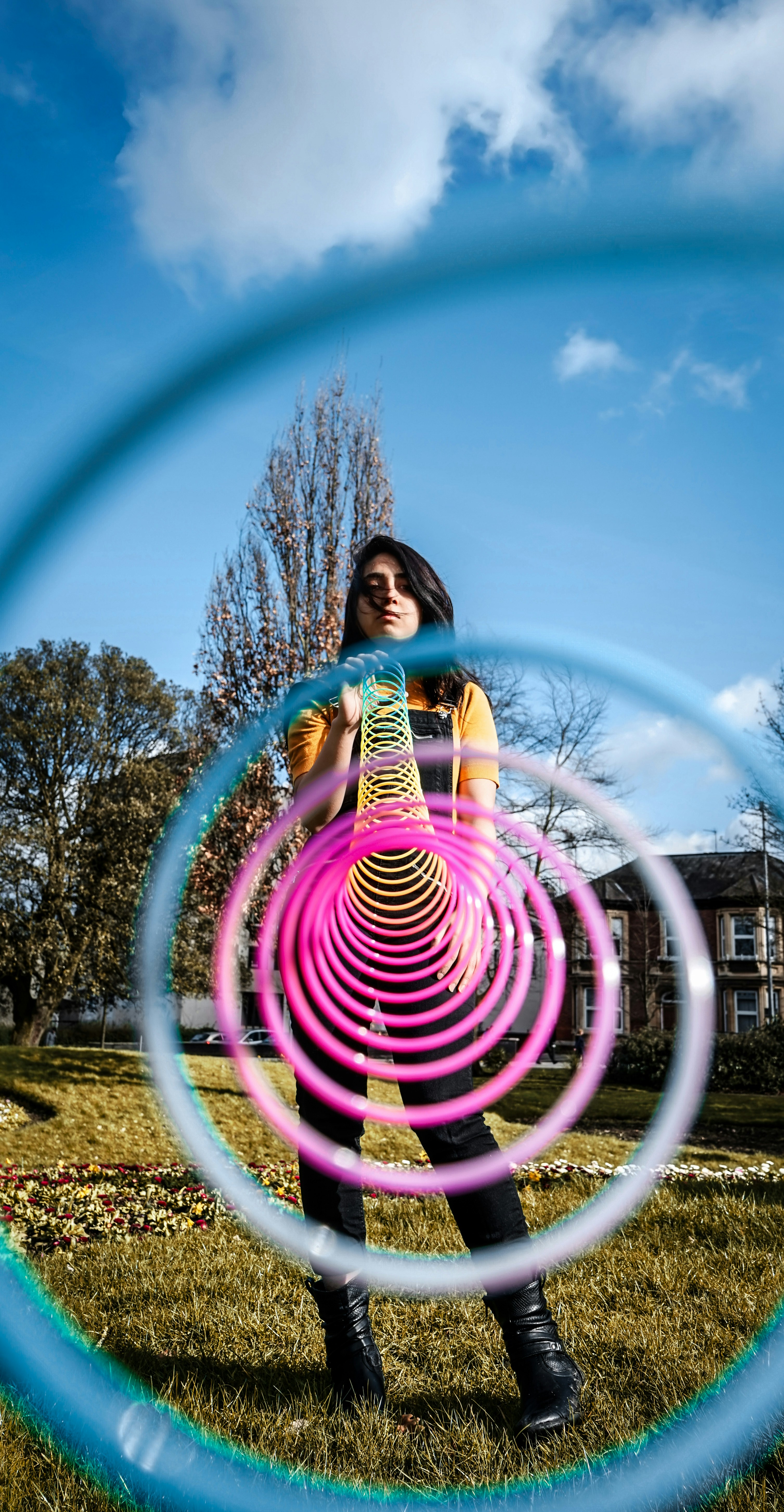 Colorful Rings Frame a Confident Figure in a Park