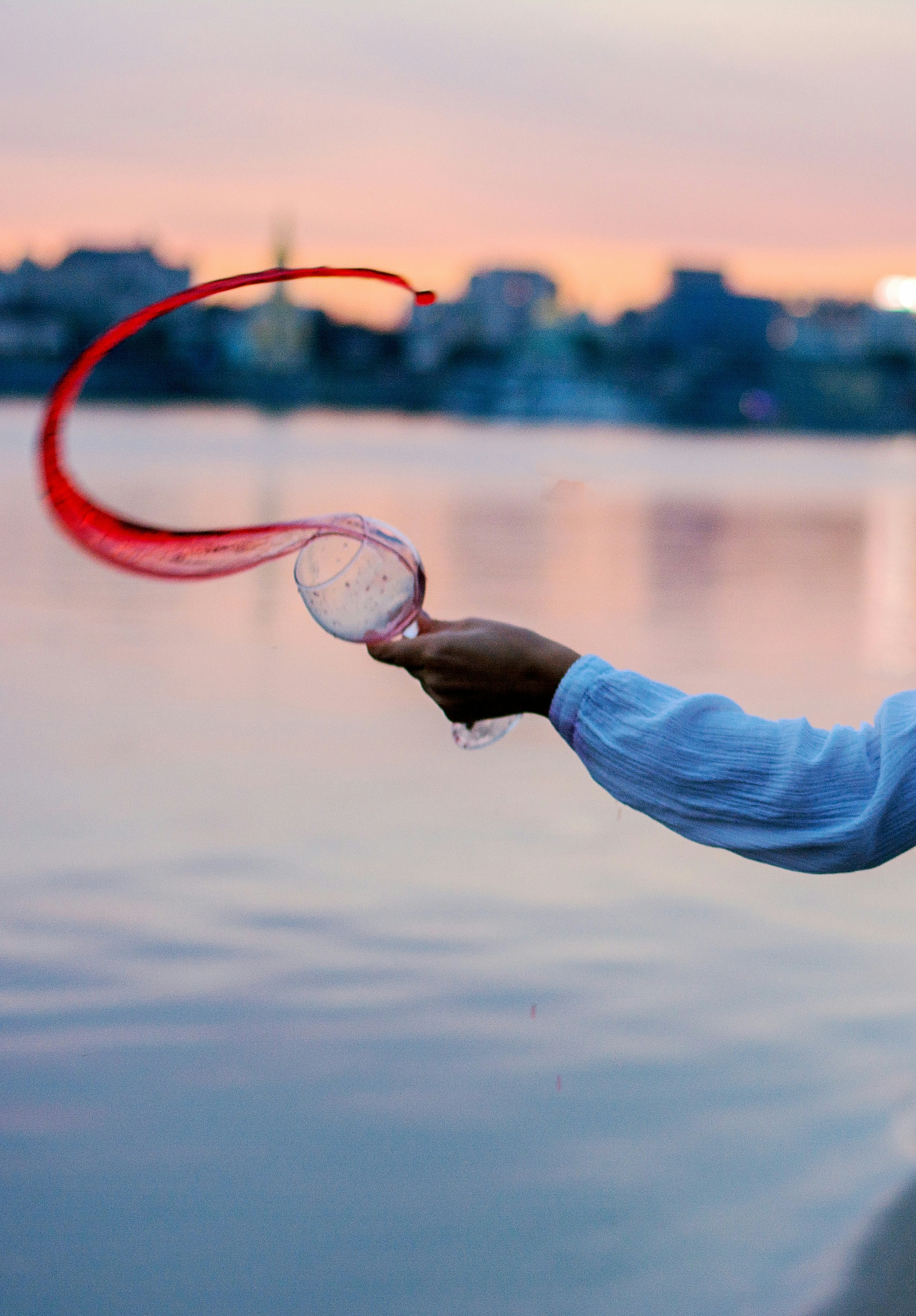 Crimson Arc Over Quiet Waters: Bubble Release at Sunset