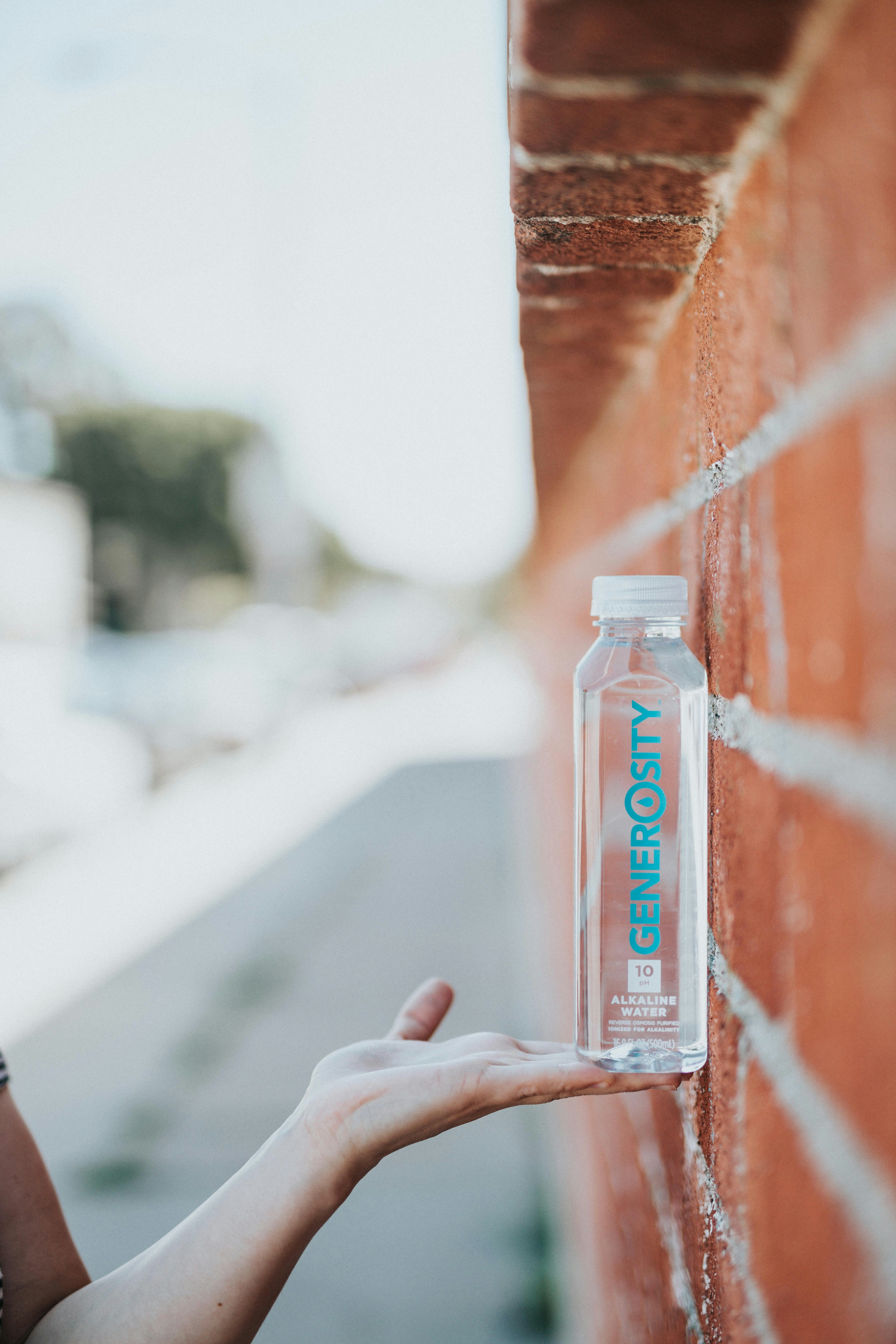 Bottle of Hydration on a Brick Wall: Generosity in Focus