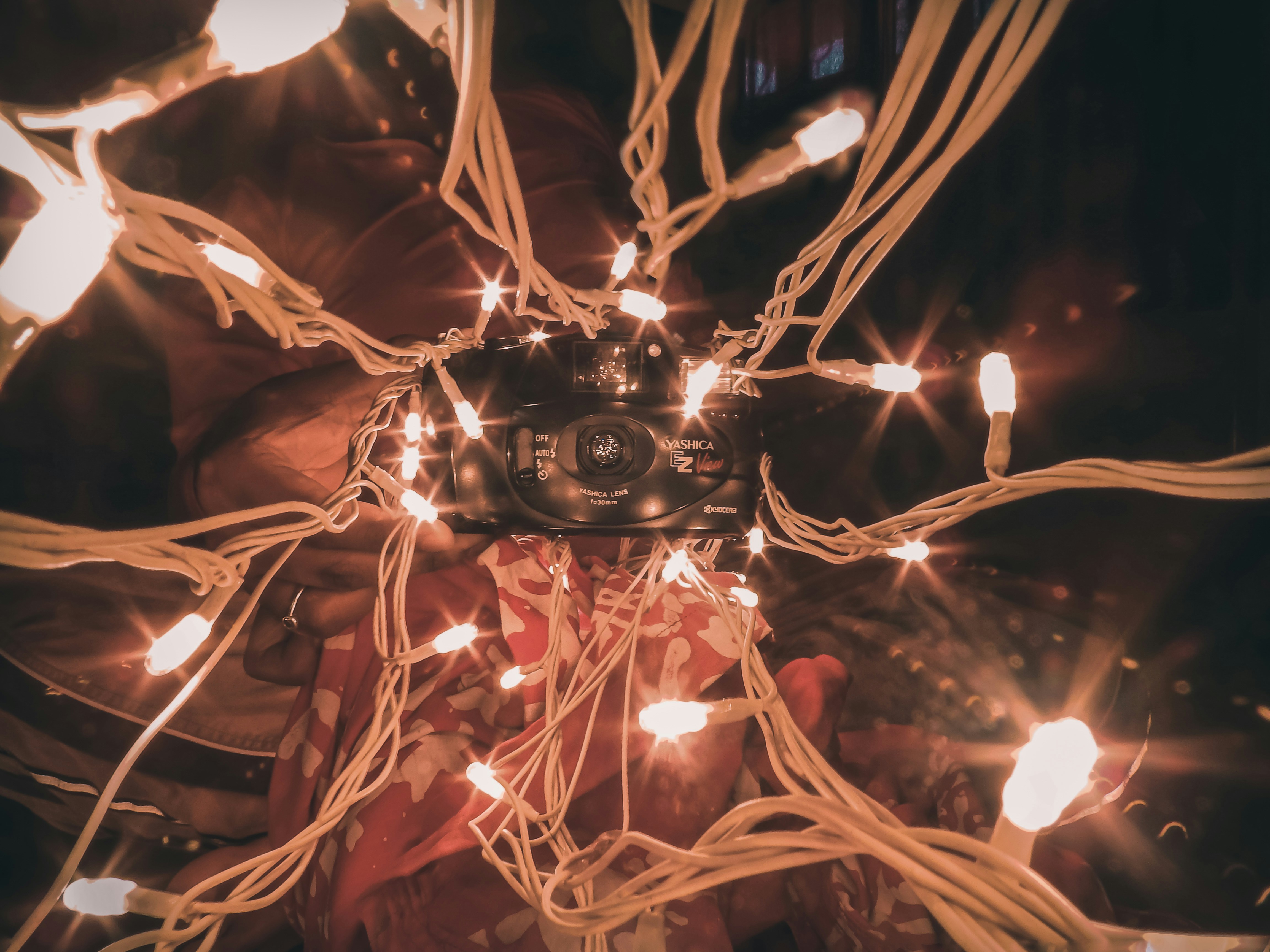 Tangled Glow: The Nikon COOLPIX P900 Surrounded by Warm Fairy Lights