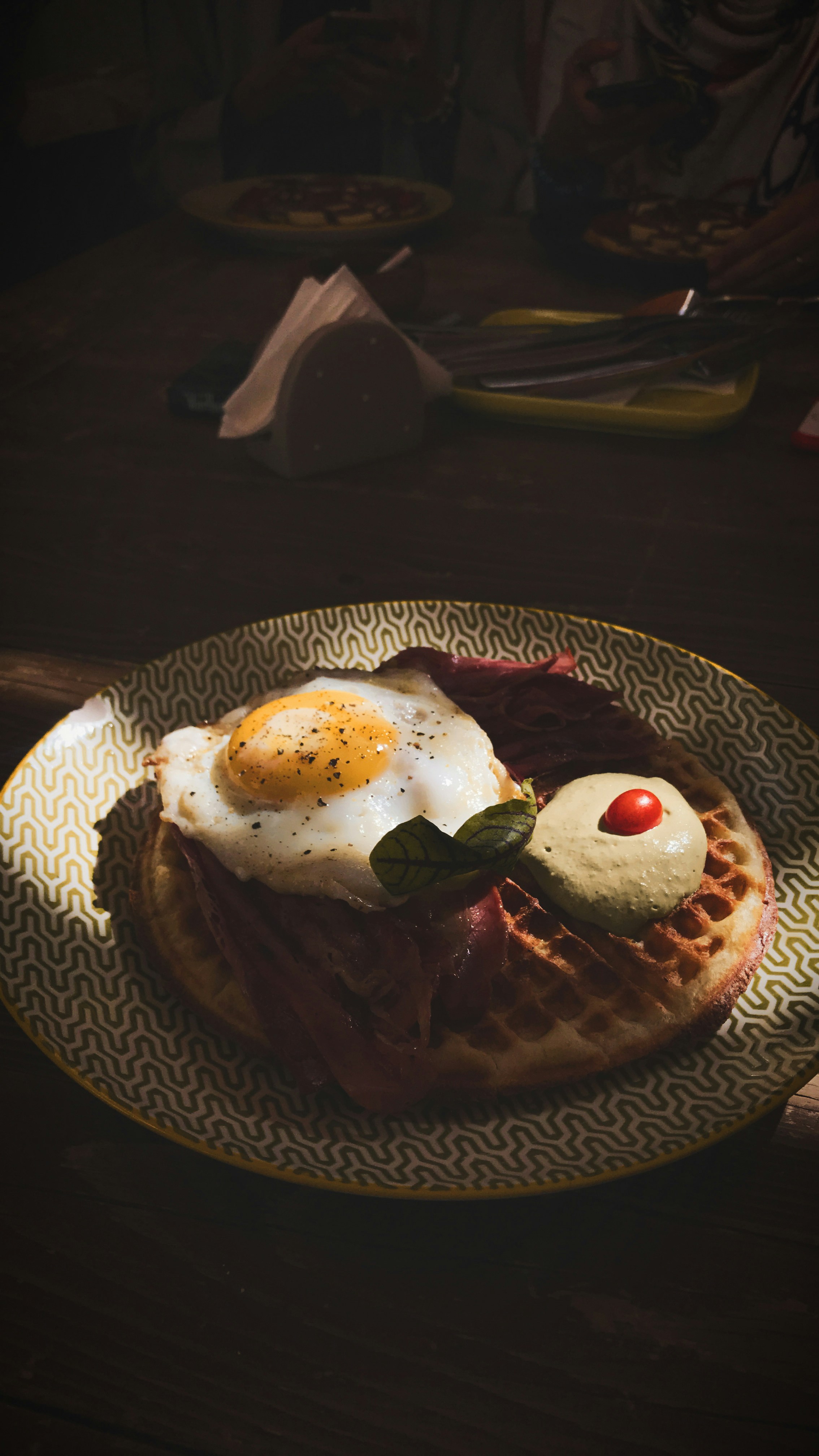 Sunlit plate: egg, prosciutto, and herb cream atop a crisp waffle