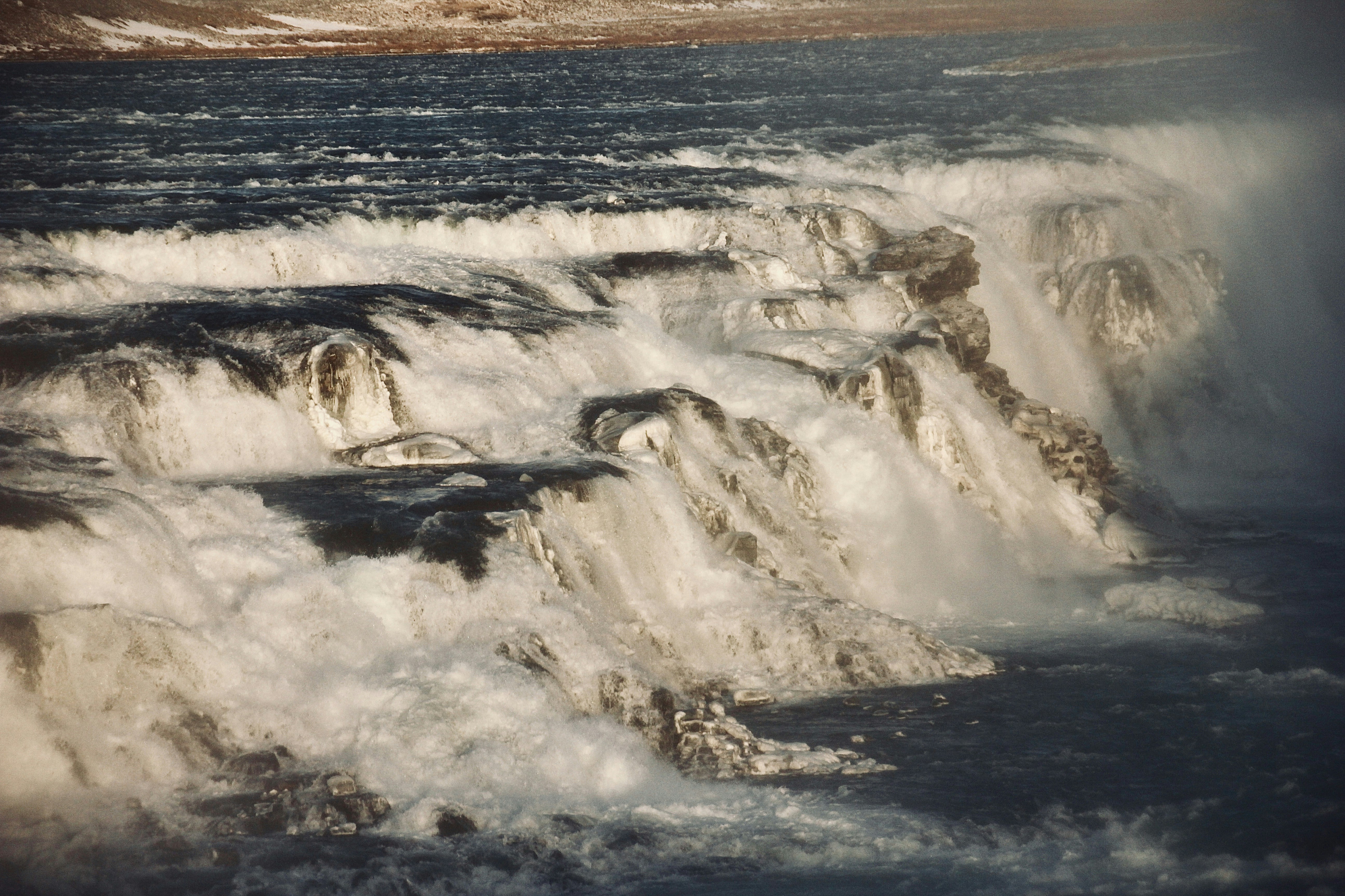 Foam Cascades Along a Weathered Coastal Verge
