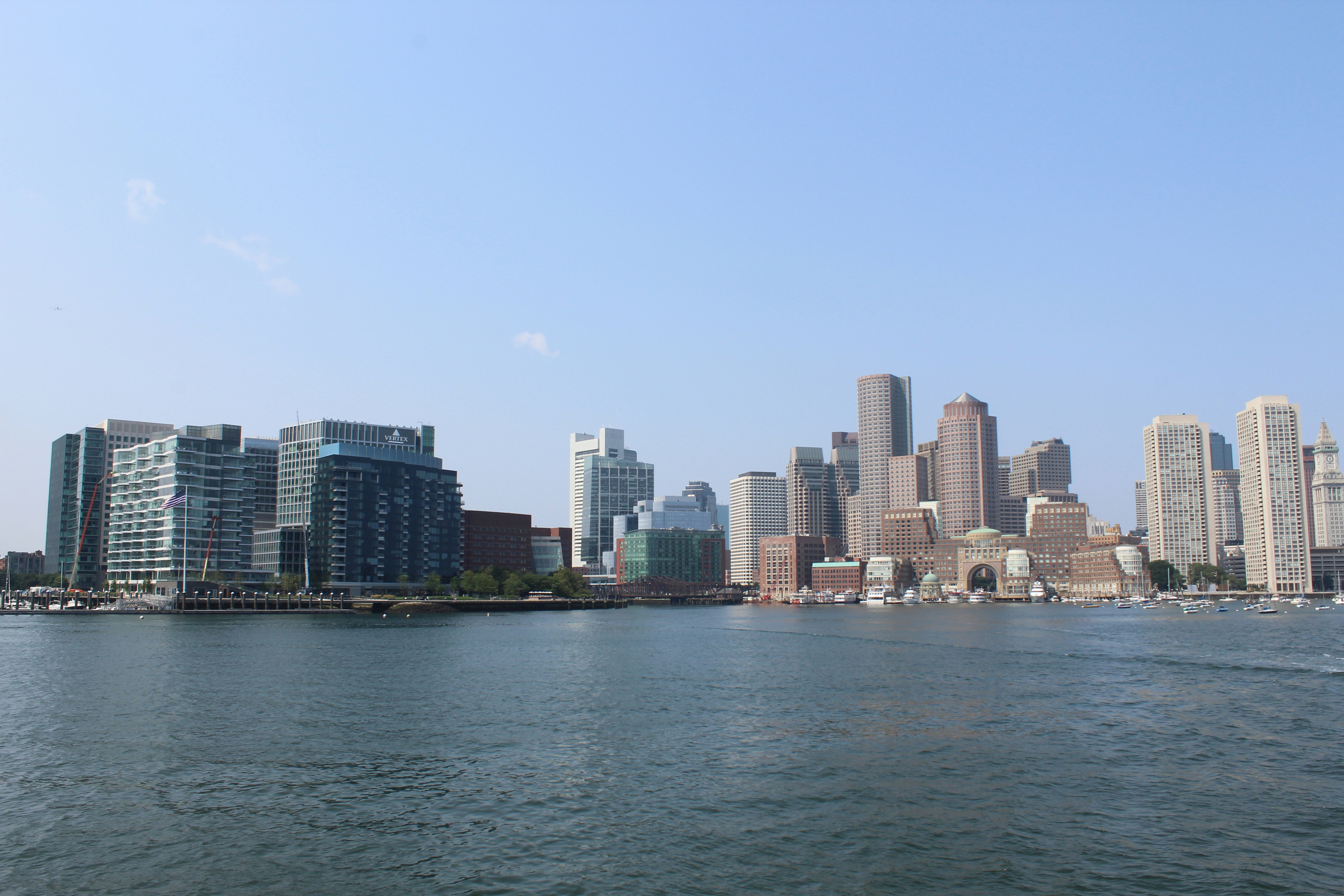 Glass and Granite: Waterfront Skyline Rises Over Calm Harbor