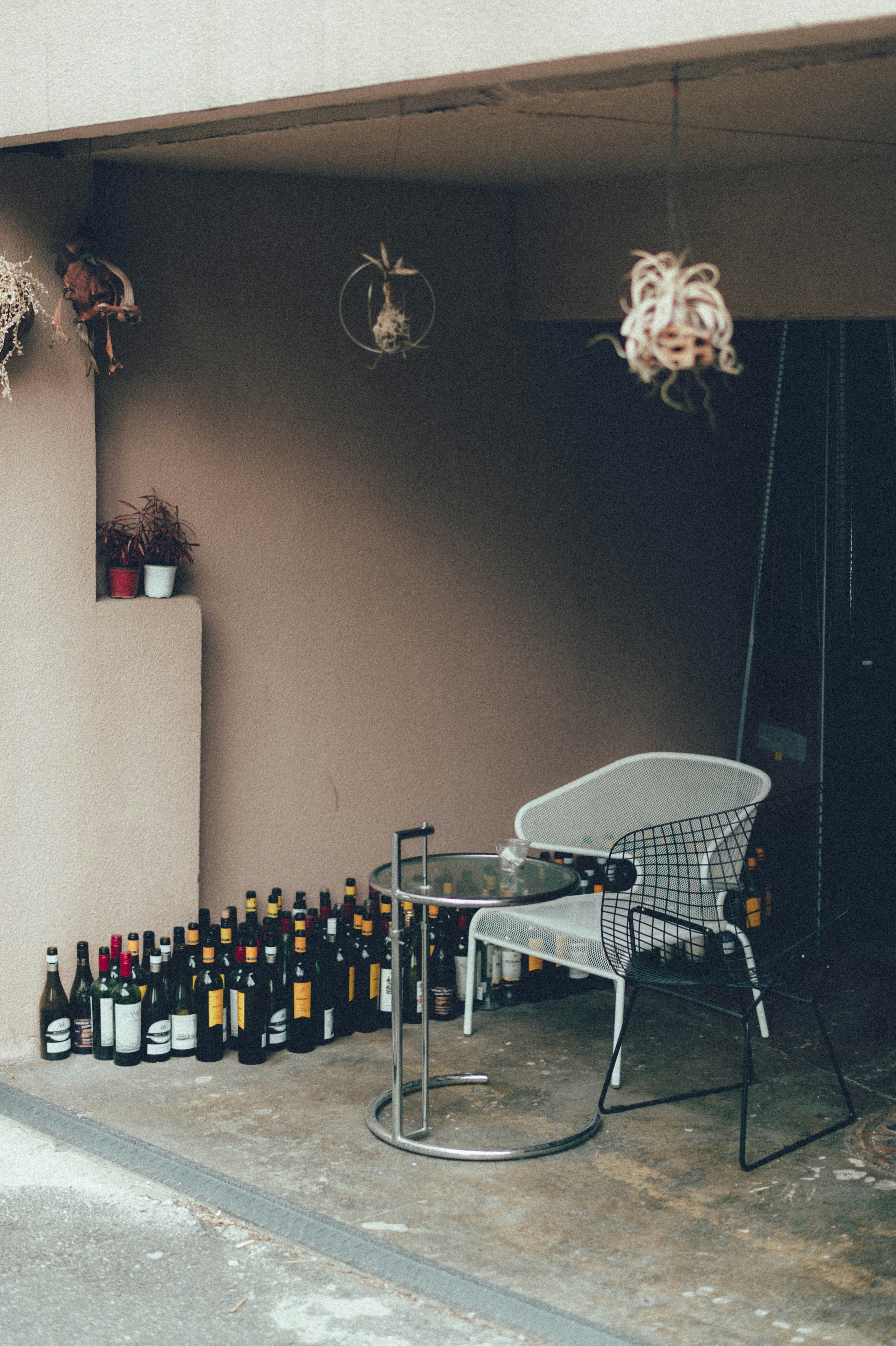 Wine Bottles and Outdoor Seating in a Quiet Courtyard