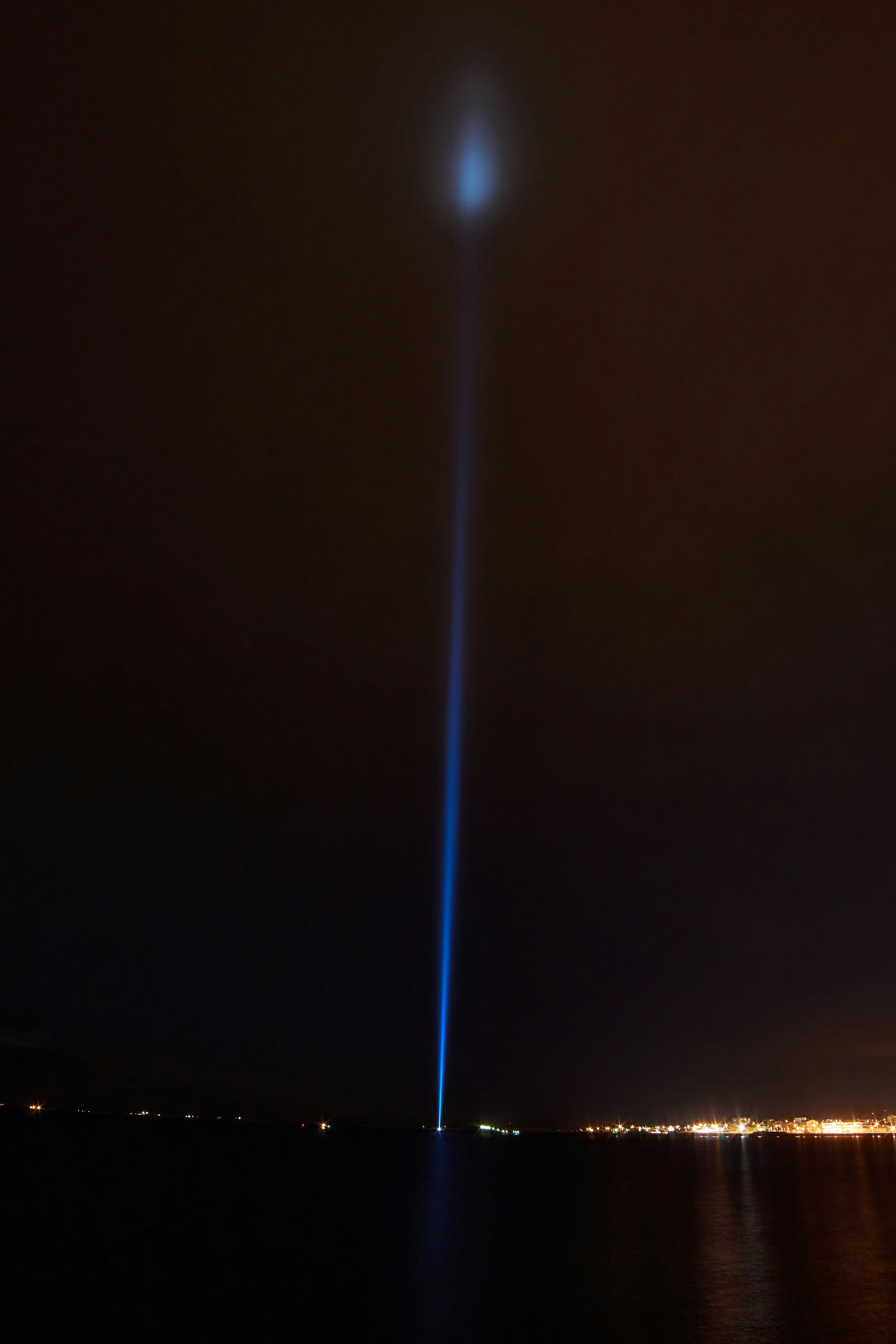 Blue Night Beam Over Quiet Harbor