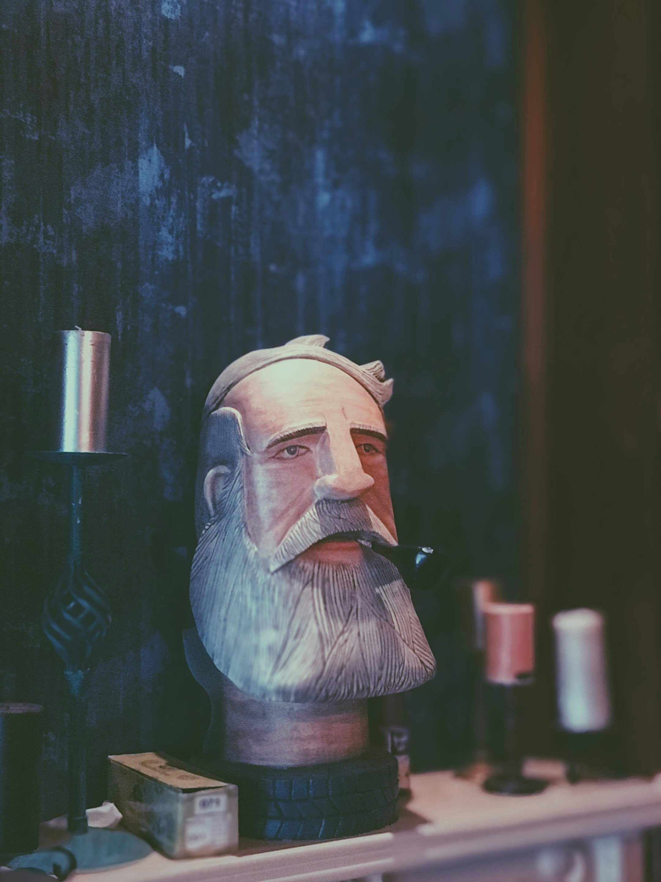 Carved Bearded Portrait: A Wooden Head Surrounded by Props