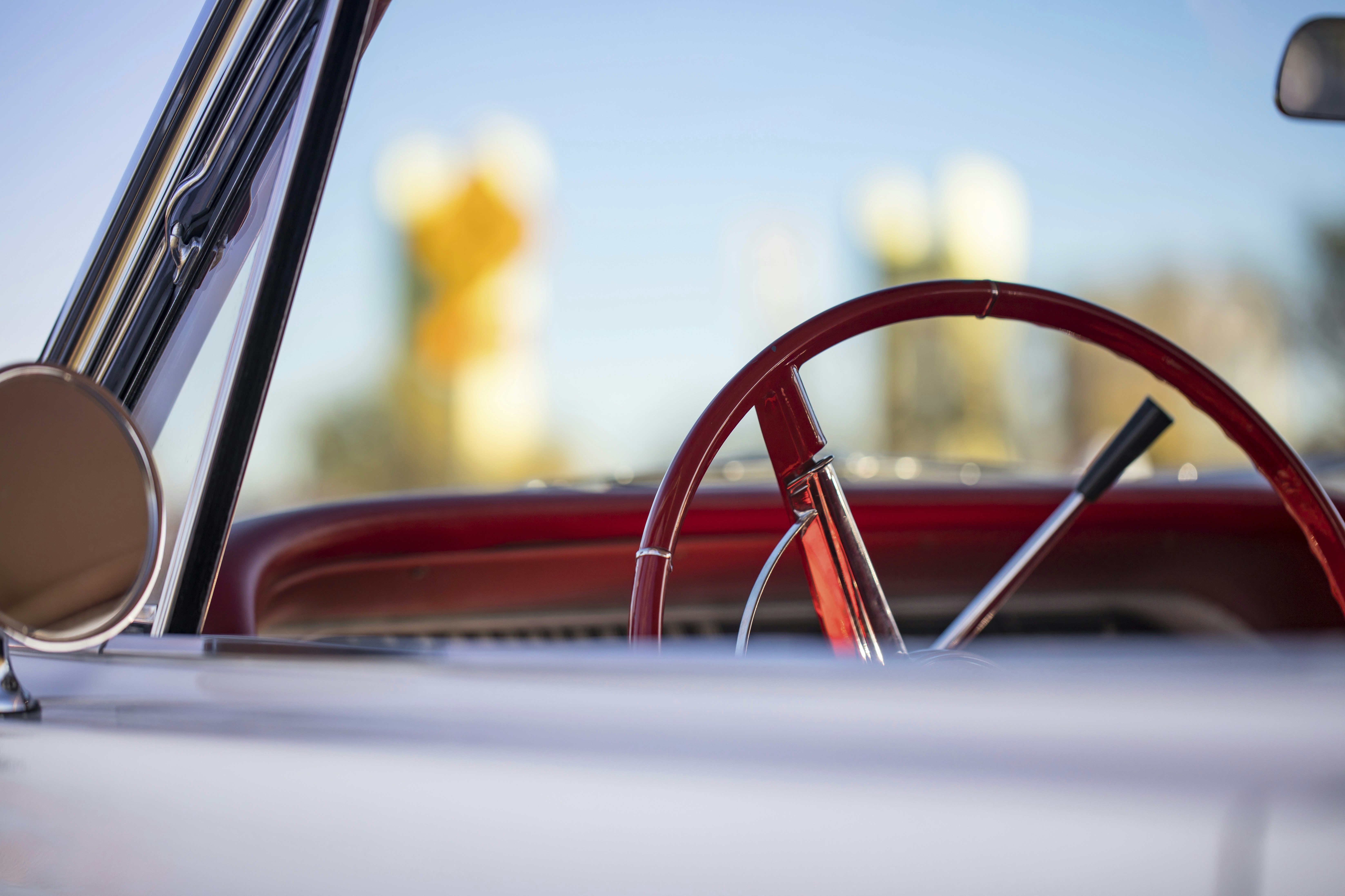Crimson Dash: Vintage Car Interior in Soft Focus Morning Light