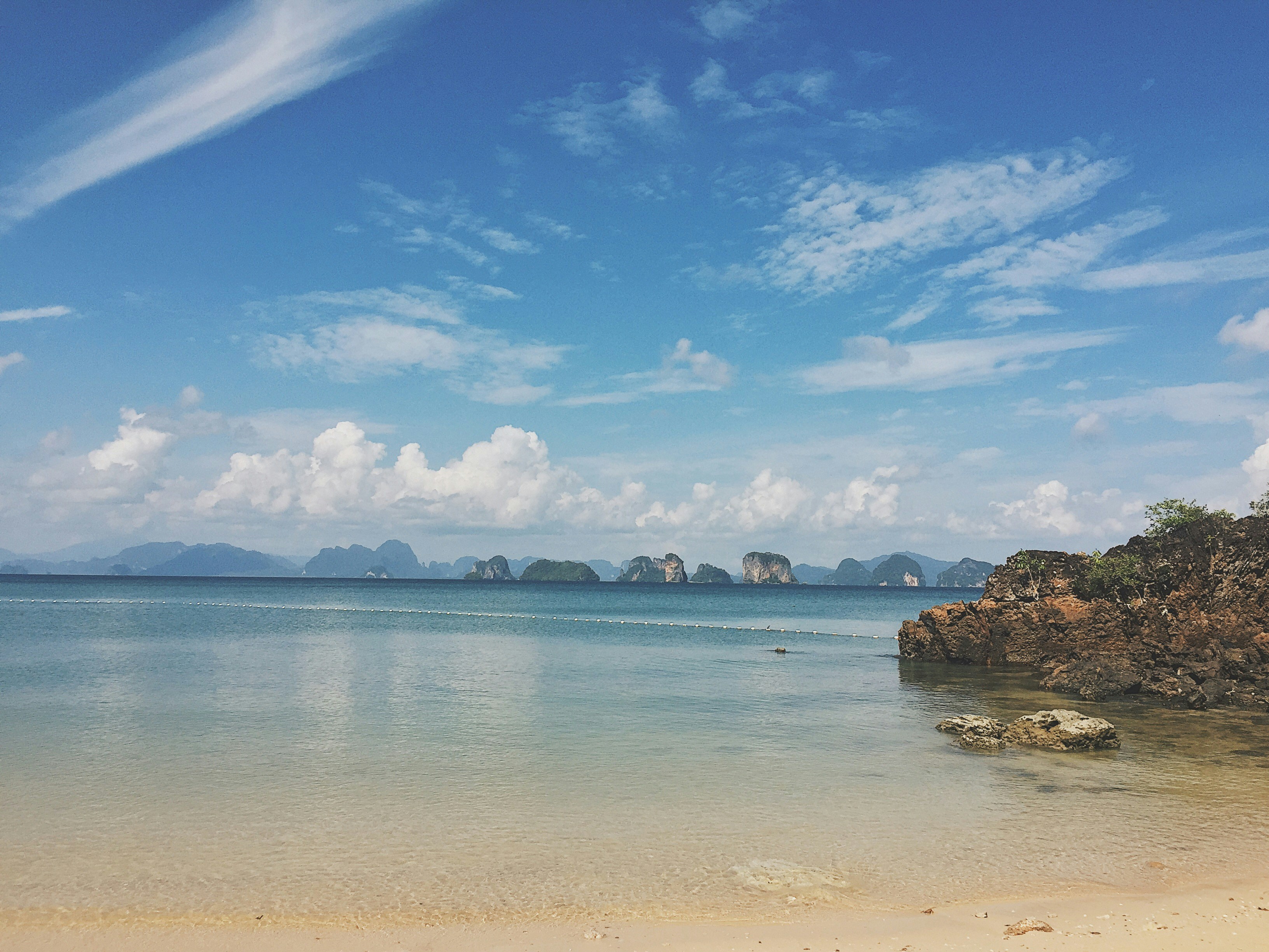 Brown rock formation on sea under blue sky during daytime photo – Free ...