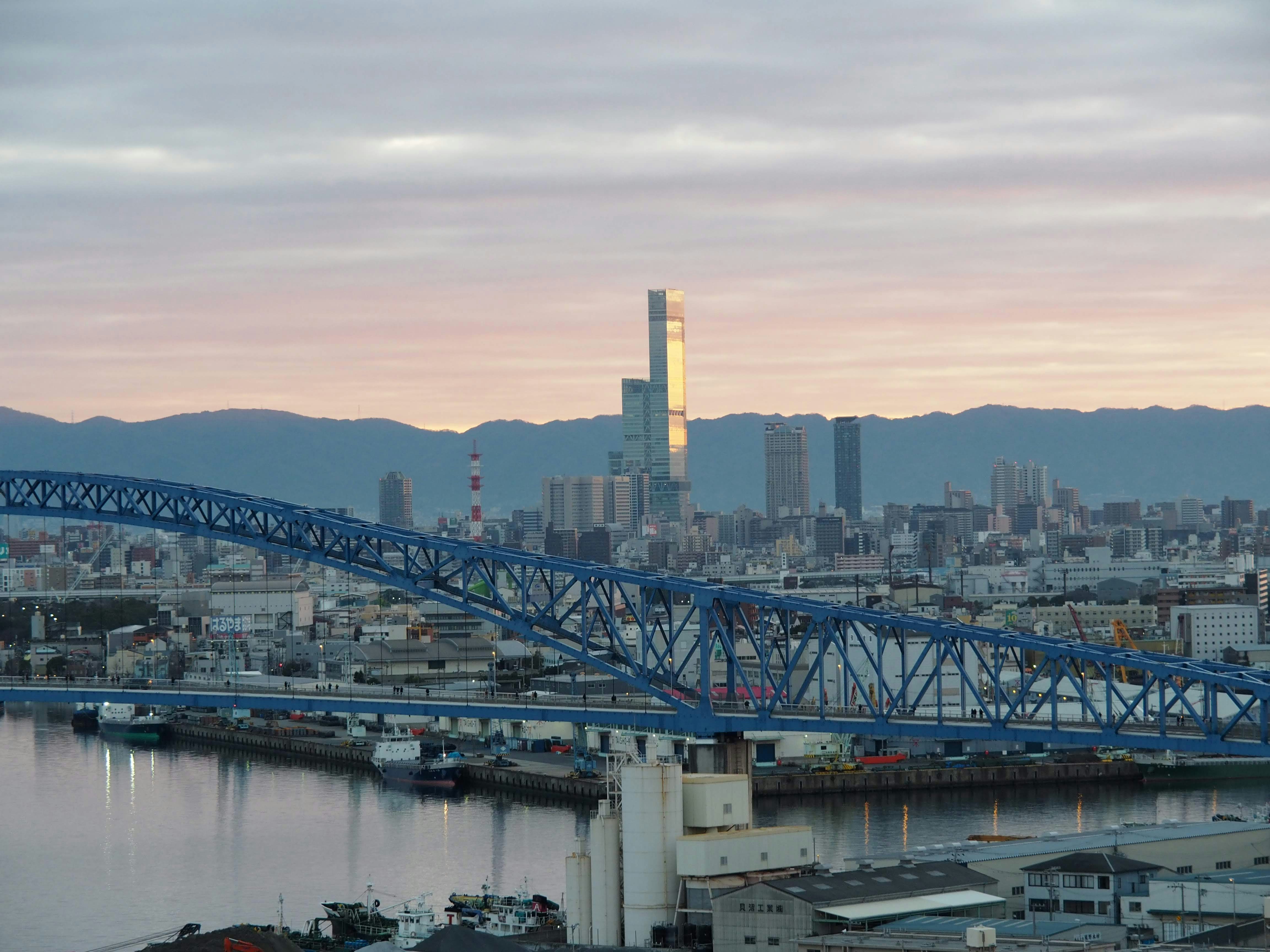Blue Span and Dawn Skyline Over a Quiet Waterfront