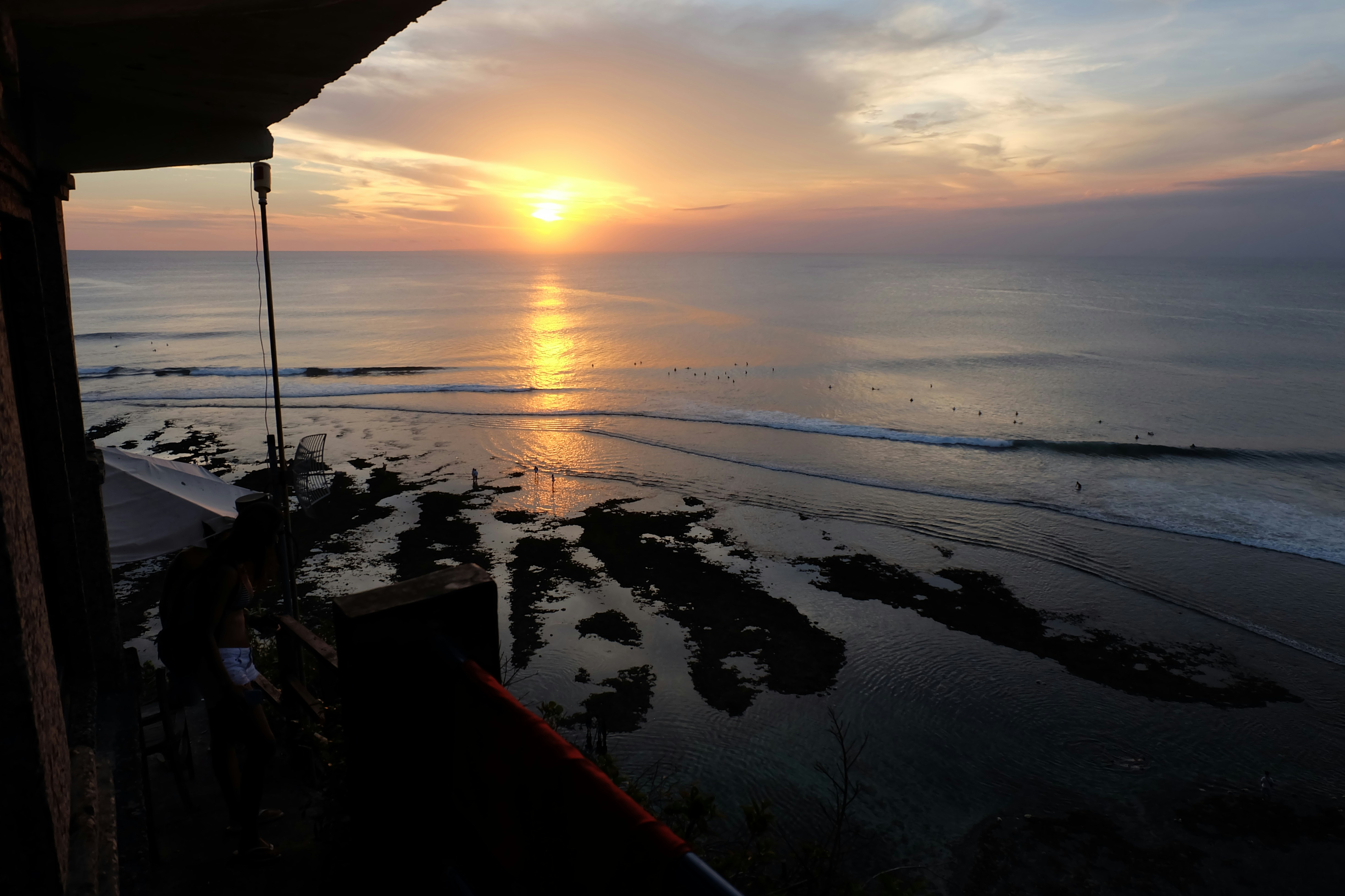 Cliffside Sunset: Golden Light Across a Quiet Sea from a Balcony