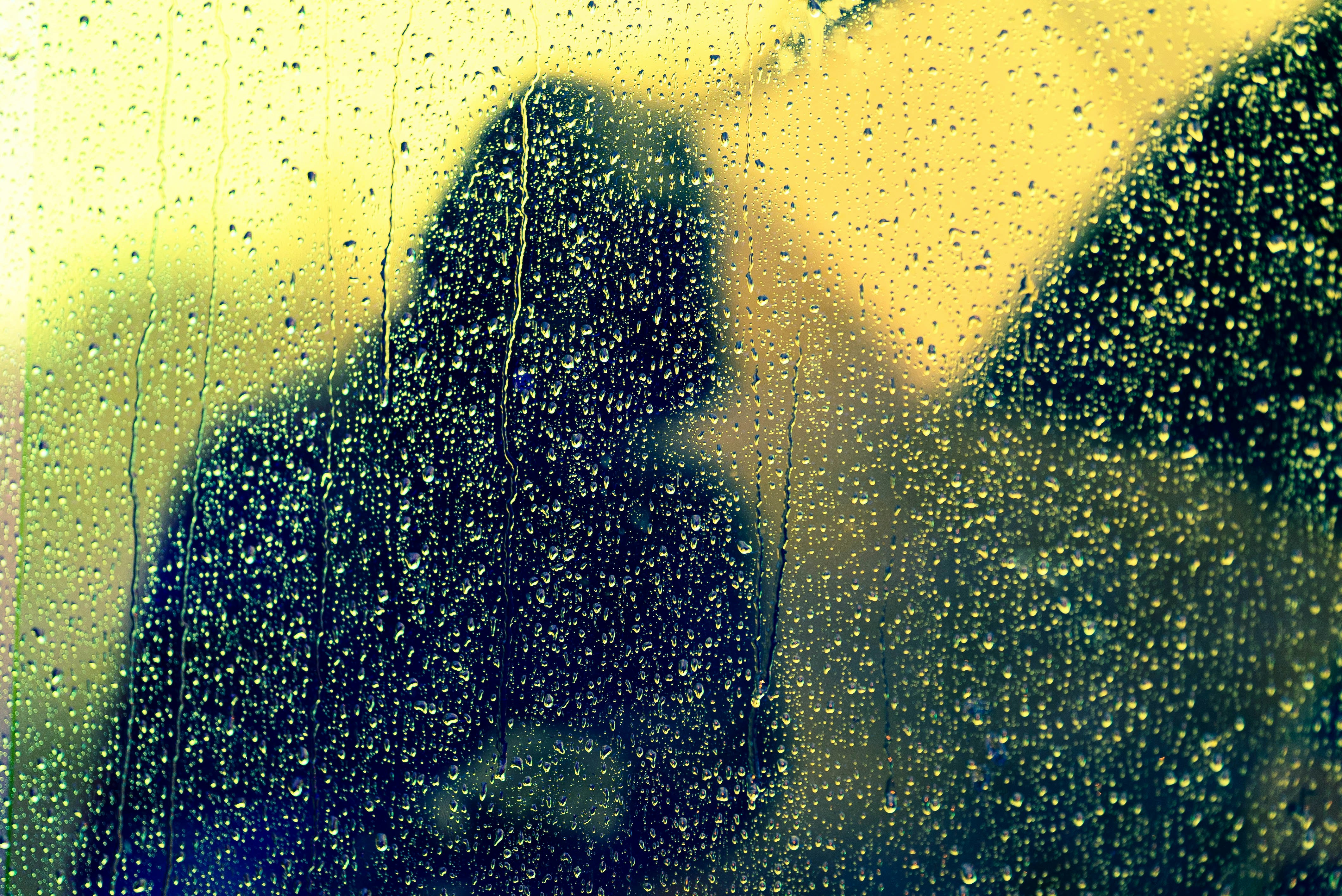 Silhouette in Rain-Soaked Glass: A Quiet, Cinematic Portrait