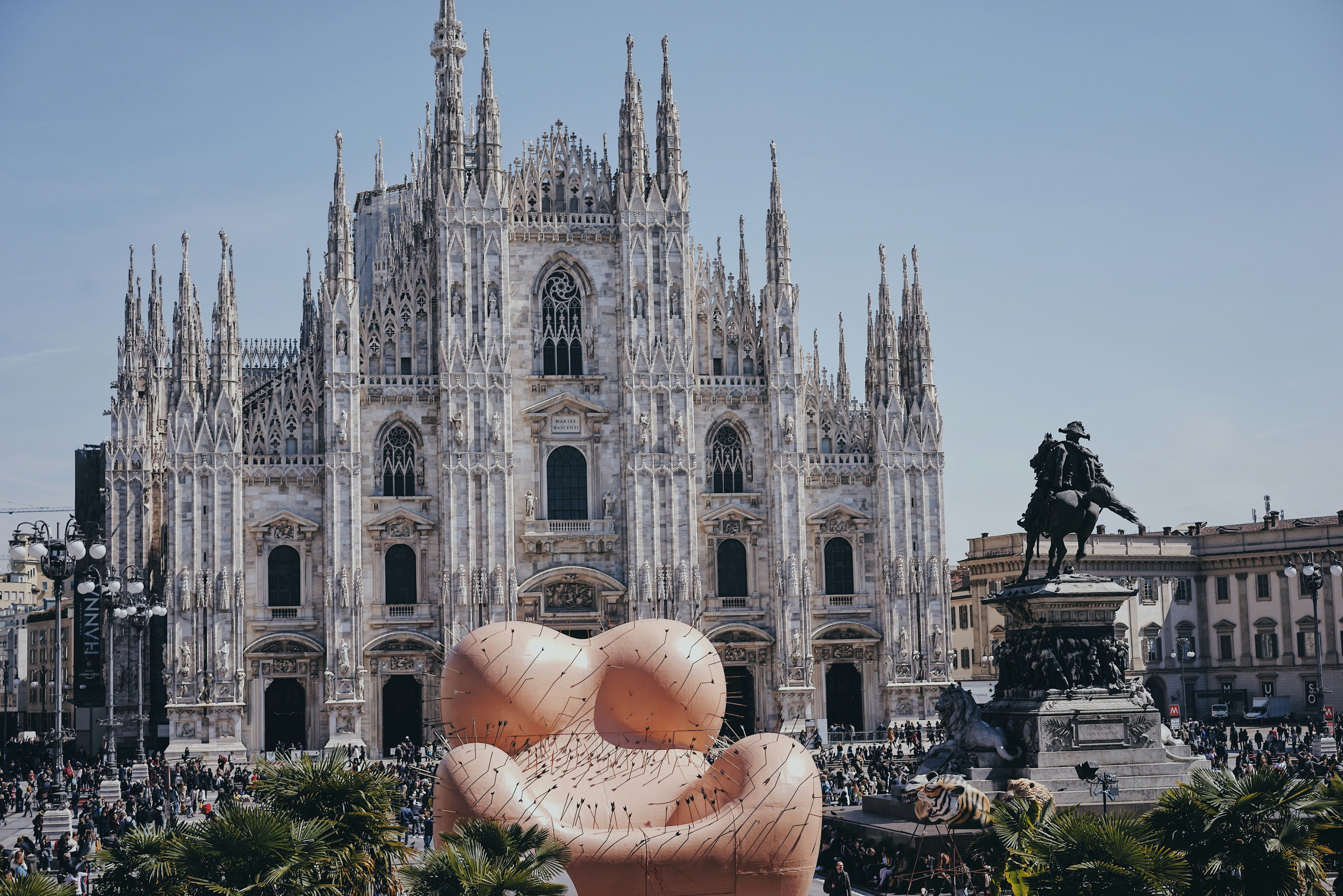Giant Pink Hand Sculpture Framing Milan Cathedral in Piazza del Duomo