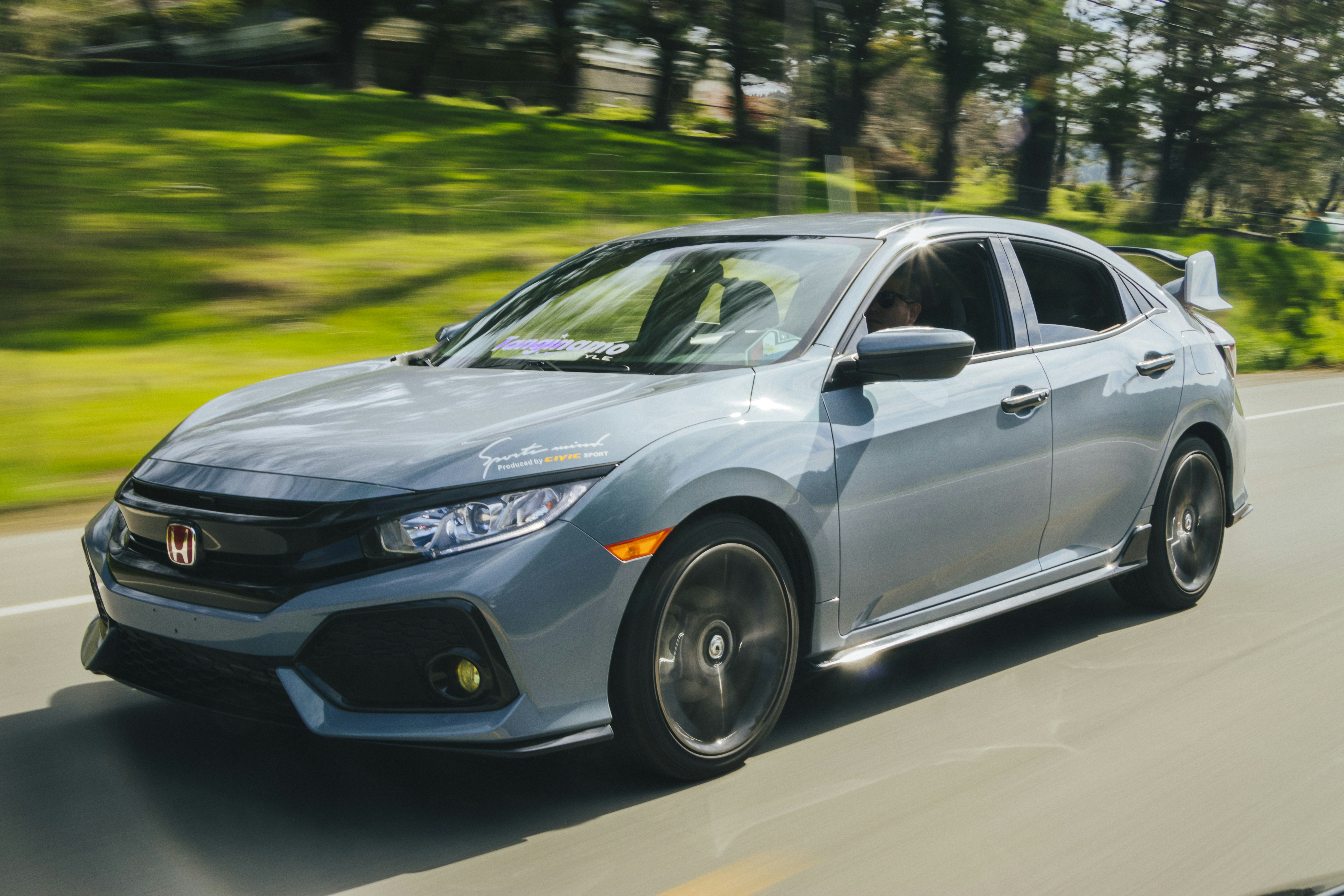 Aerodynamic Silver Surge: Honda Civic Si in Motion