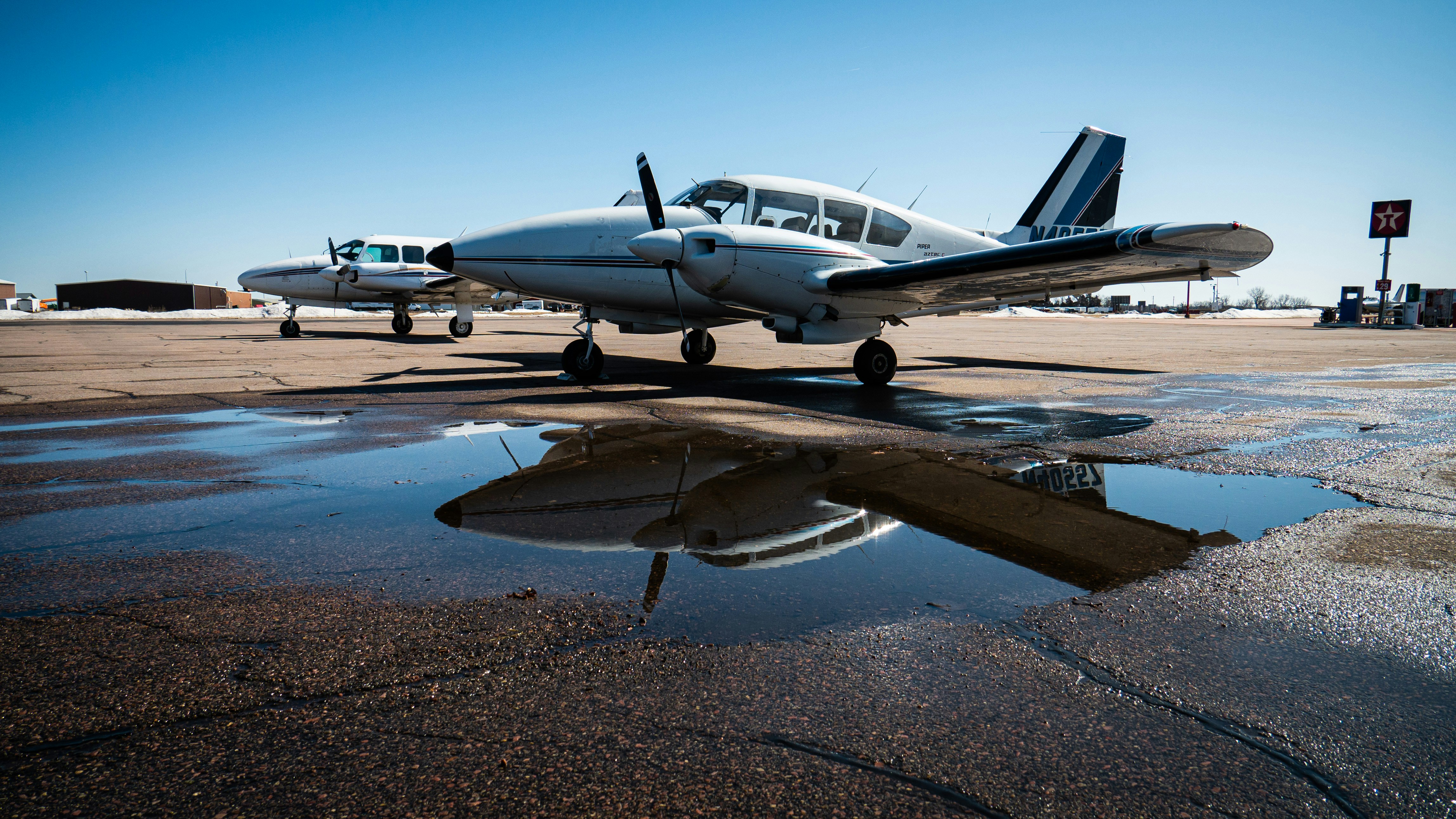 White and blue airplane on brown sand during daytime photo – Free ...