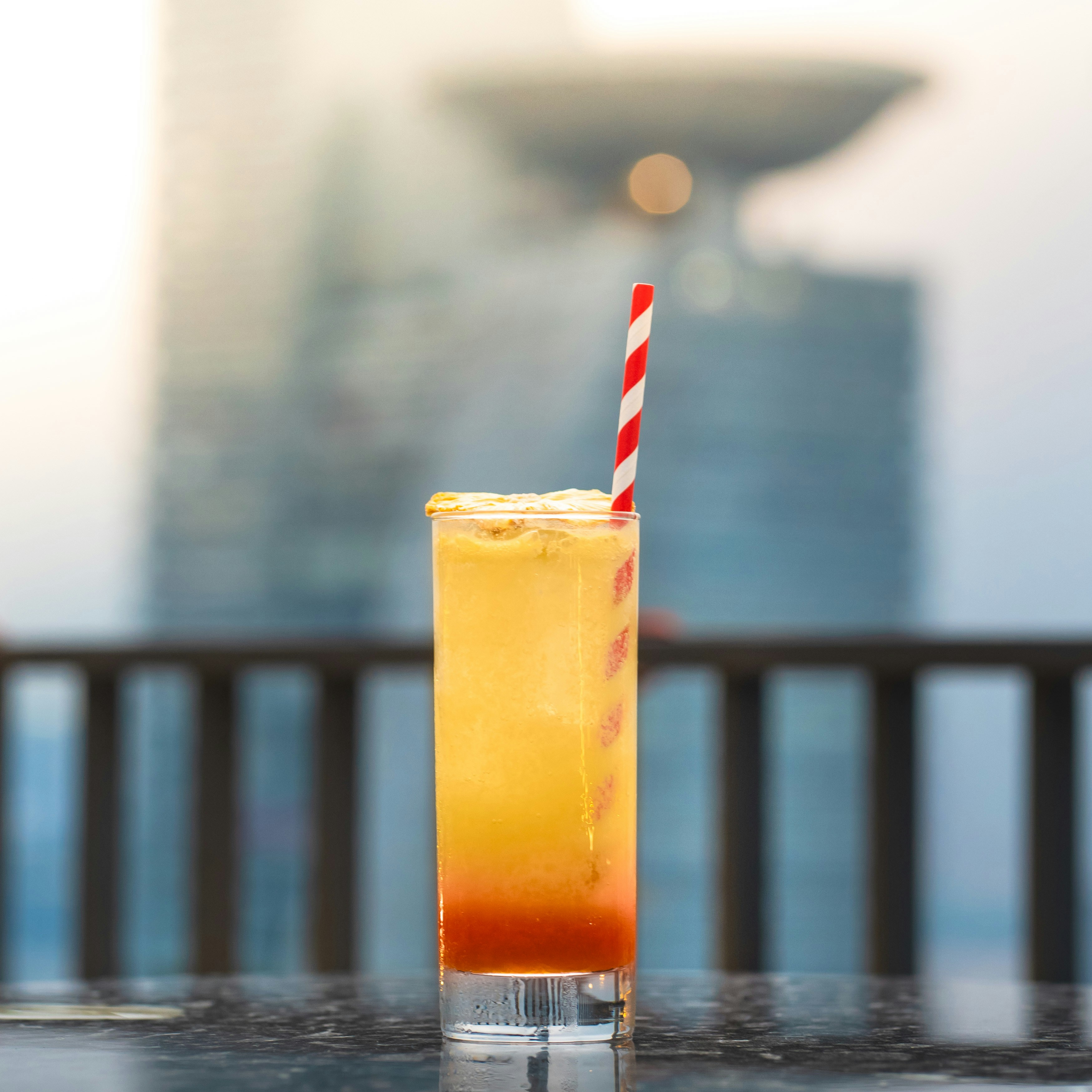 Glass of Sunset on a City Balcony