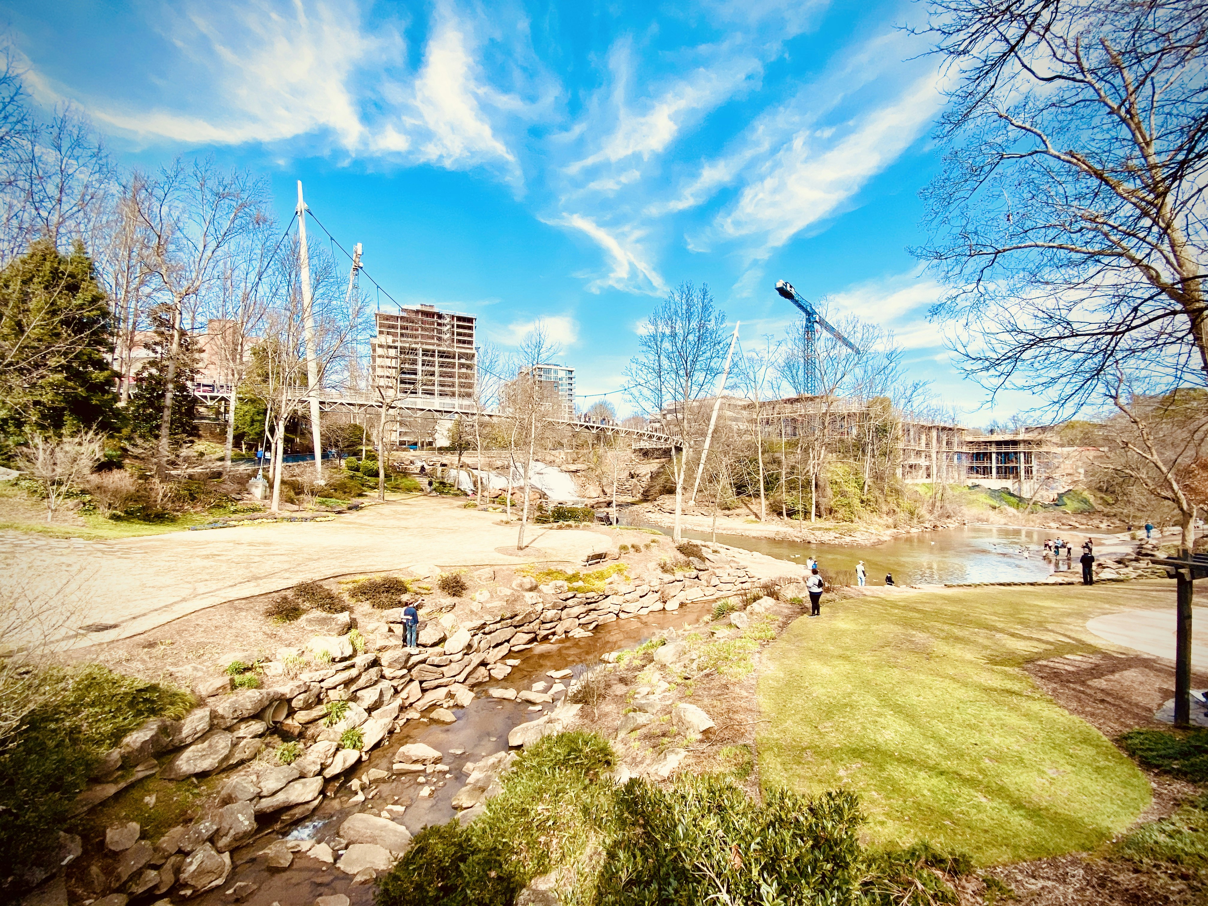 Falls Park | bare trees near white building under blue sky during daytime