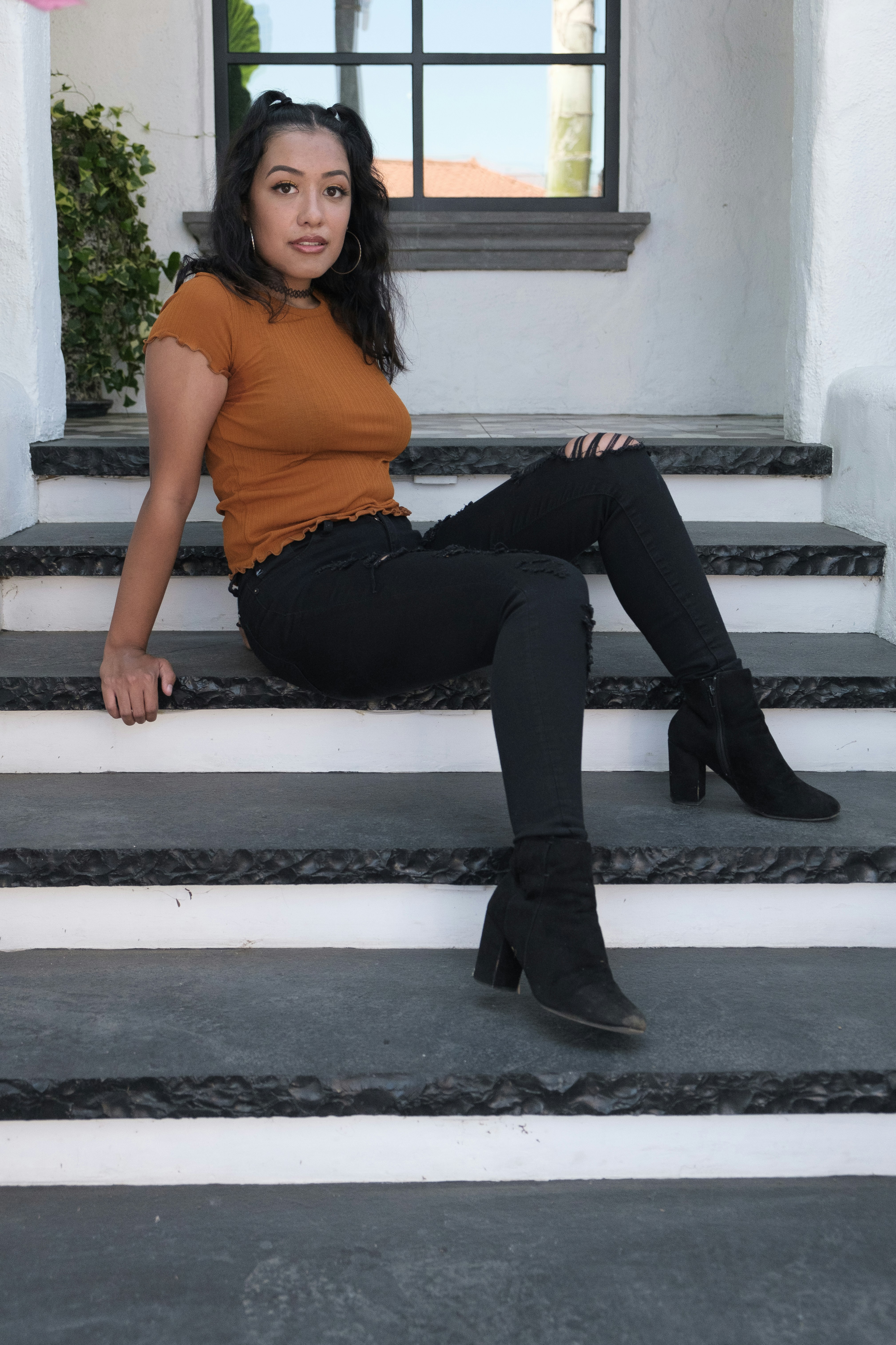 Terracotta Tee on Granite Steps: A Confident Portrait