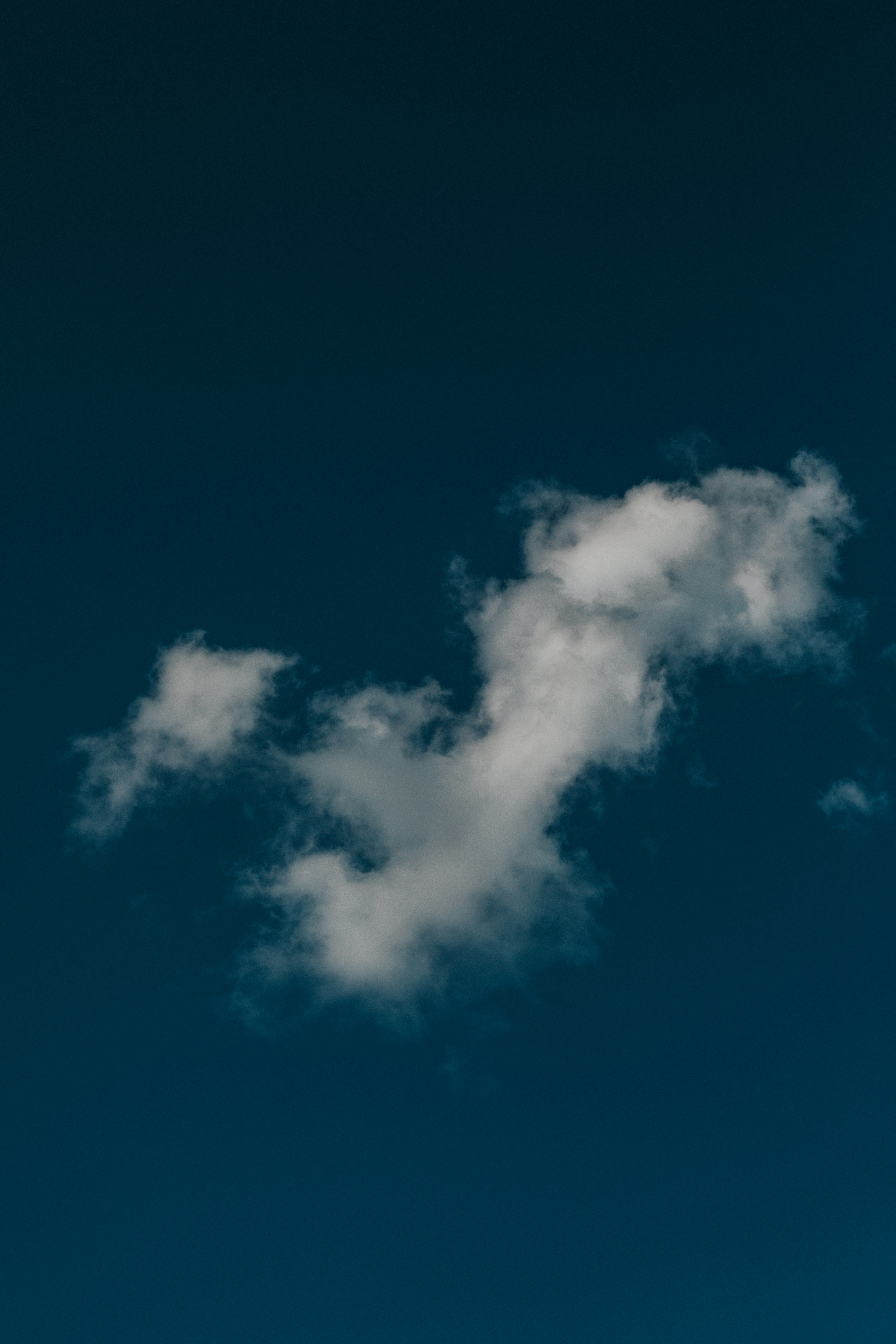 Cobalt Sky, a Lone Cloud Drifting Across Quiet Blue