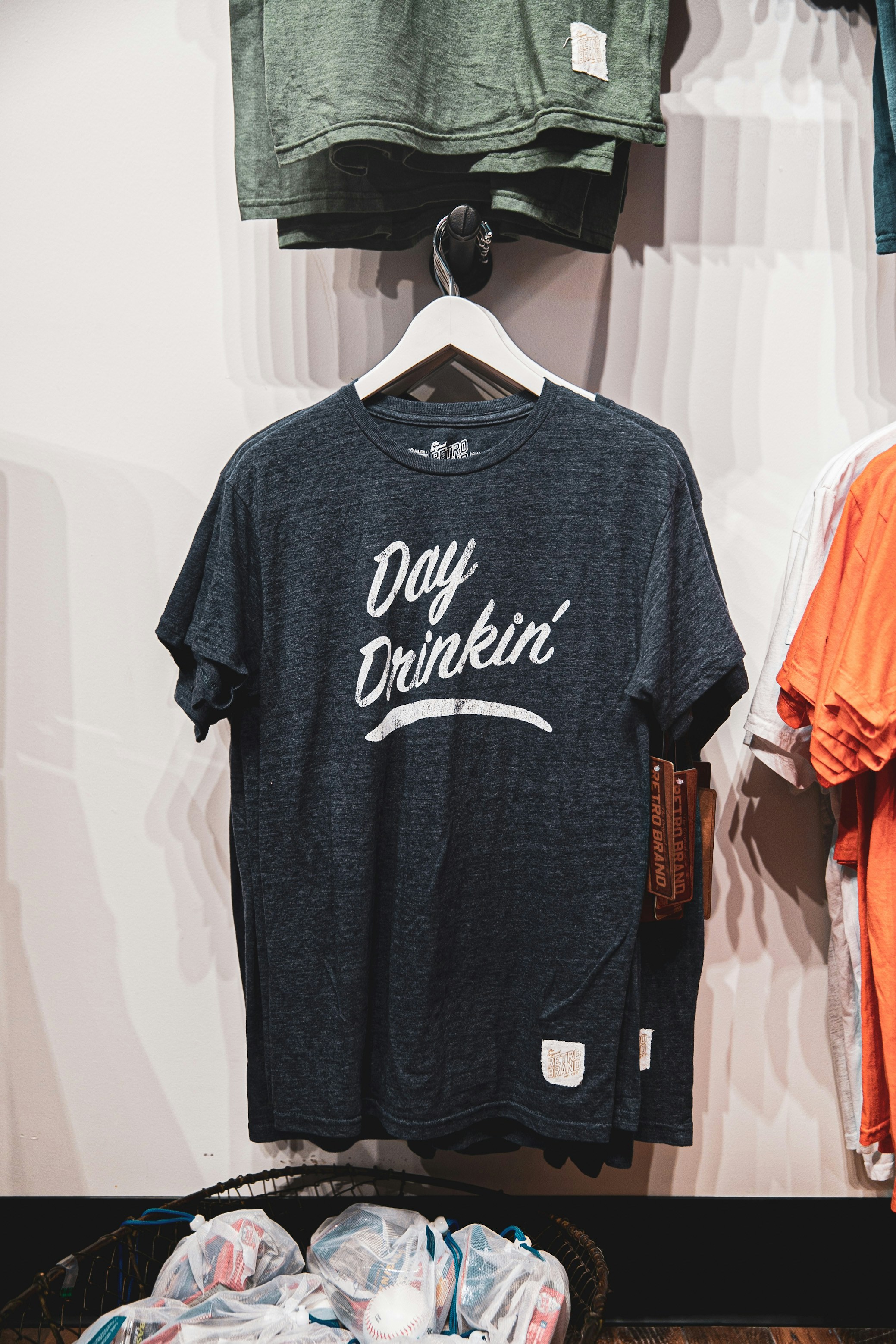 Day Drinkin’ Tees: A Navy Shirt Centered on a Casual Hanger Display