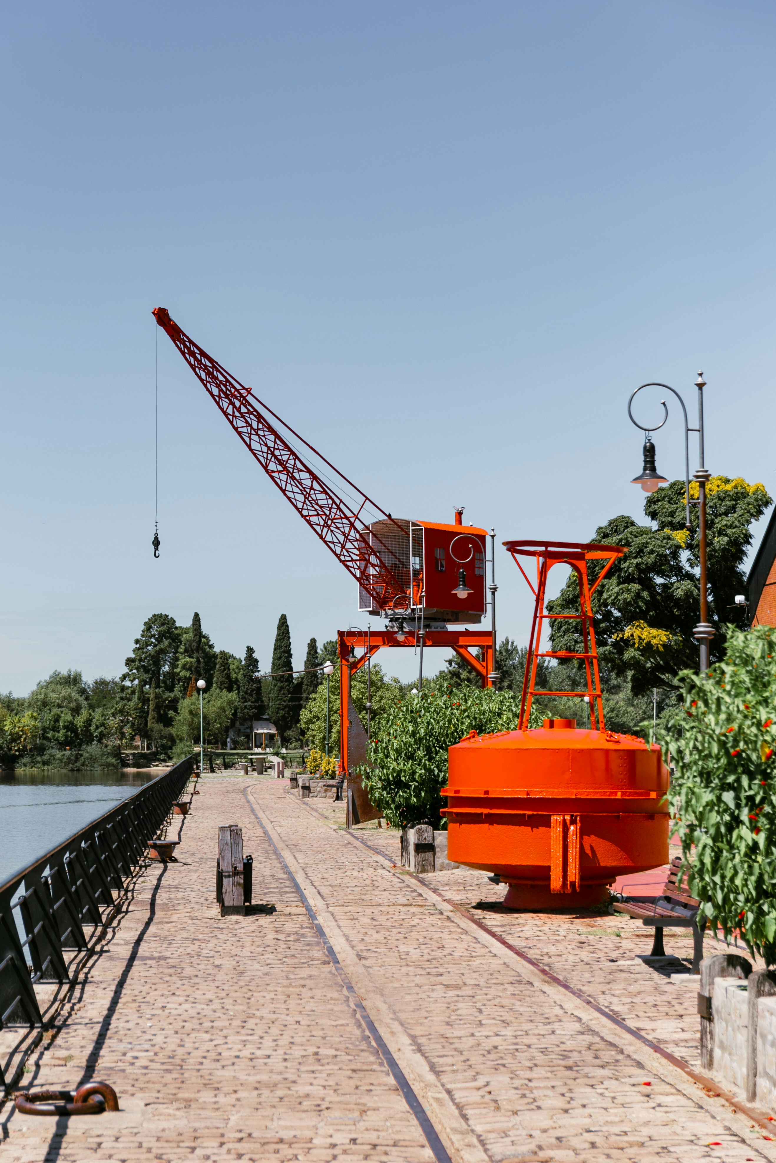 Crane at Rest along a Riverside Promenade