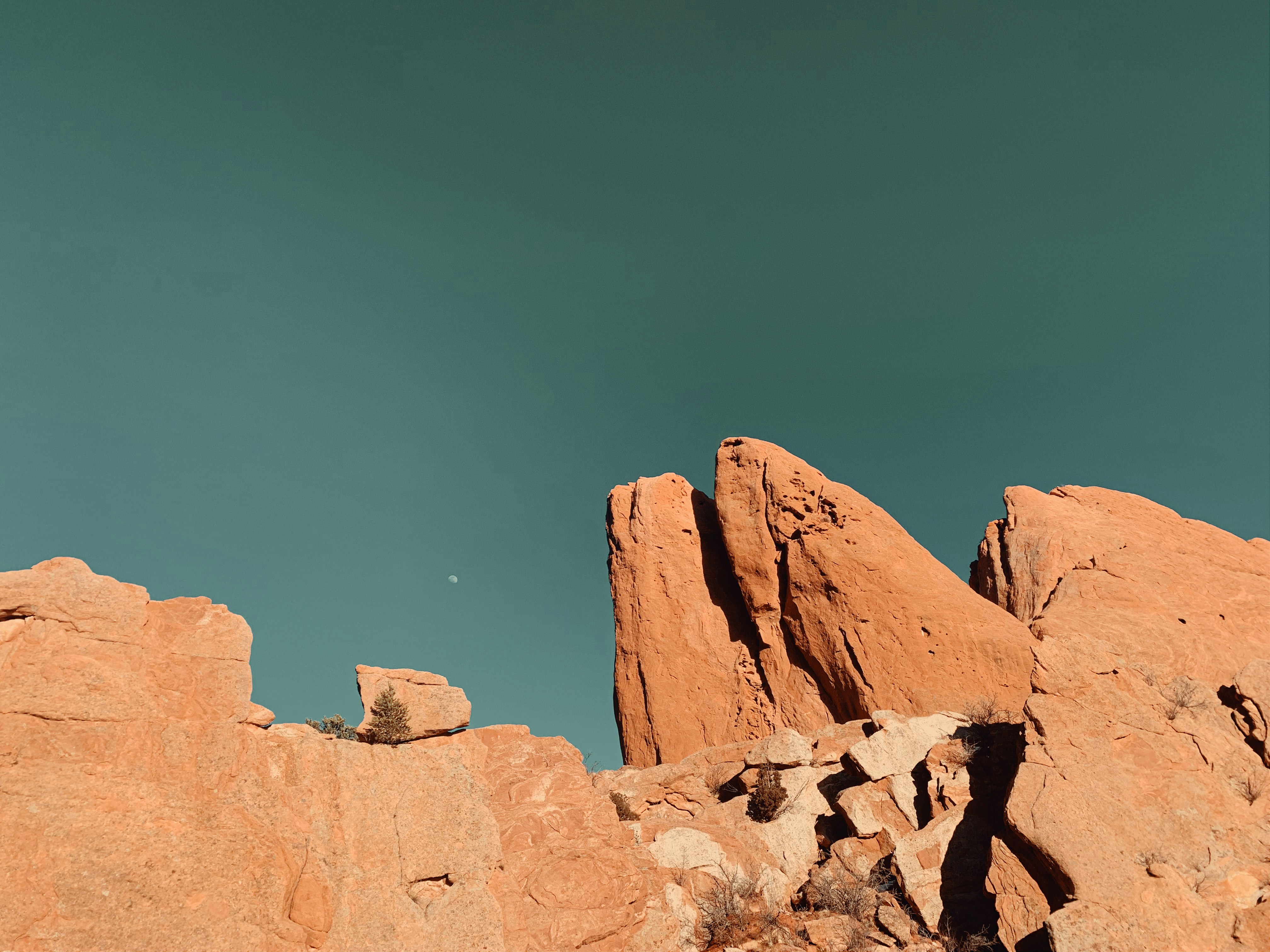 Crimson Monoliths Against a Teal Desert Sky