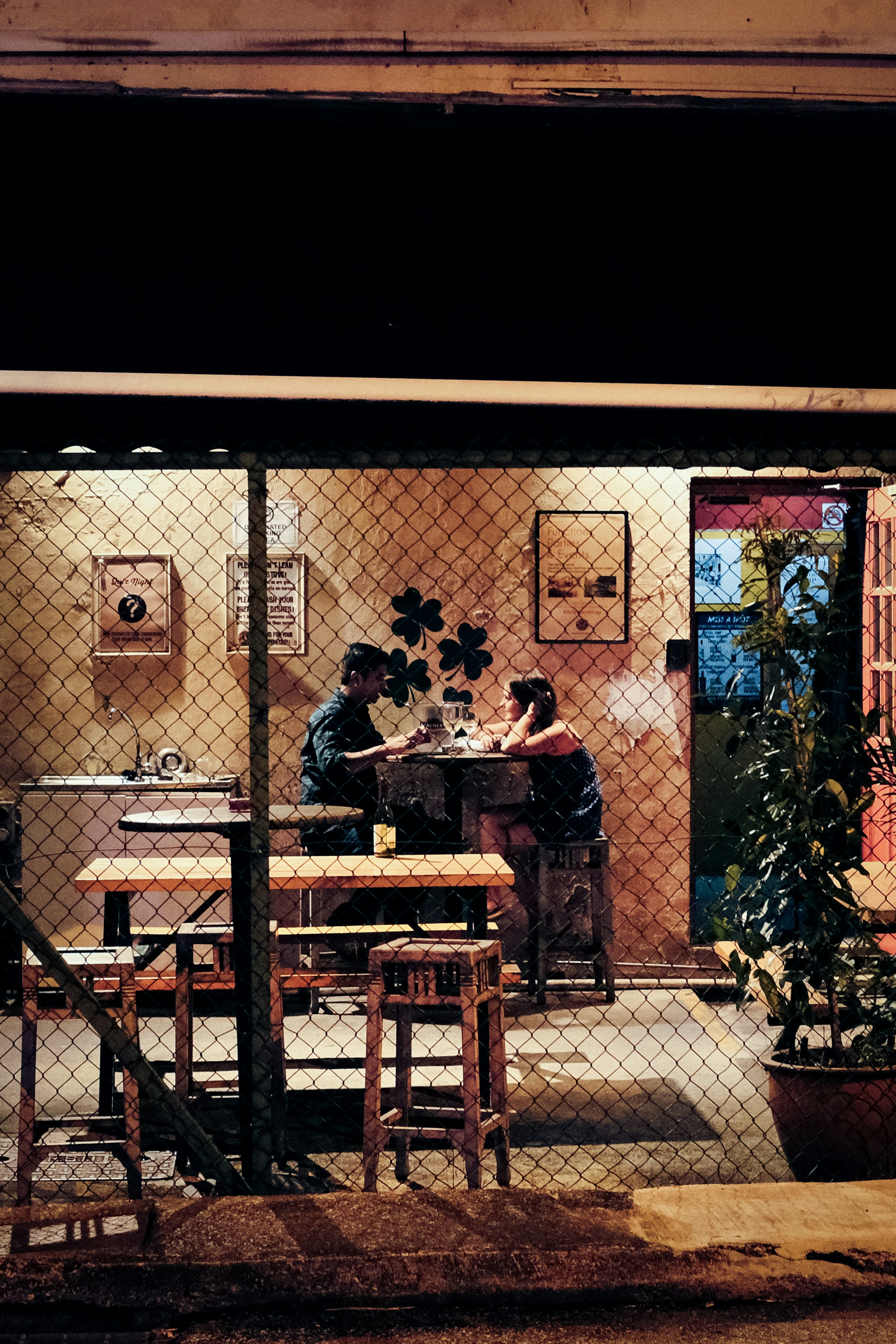 Meshbound Moments: Conversation Through the Fence at a Cozy Café