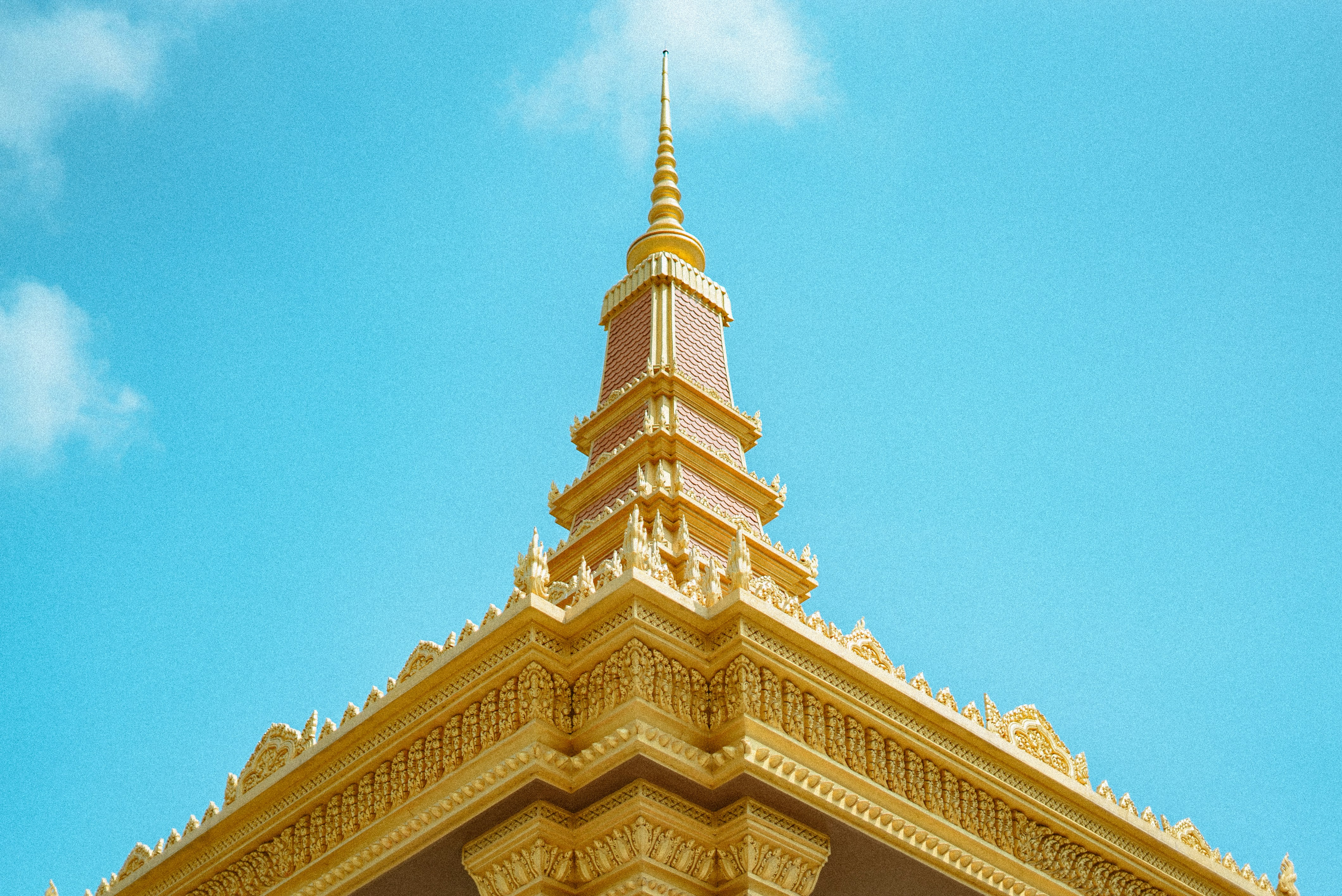 Gilded Tiered Spire Crowned by a Cerulean Sky