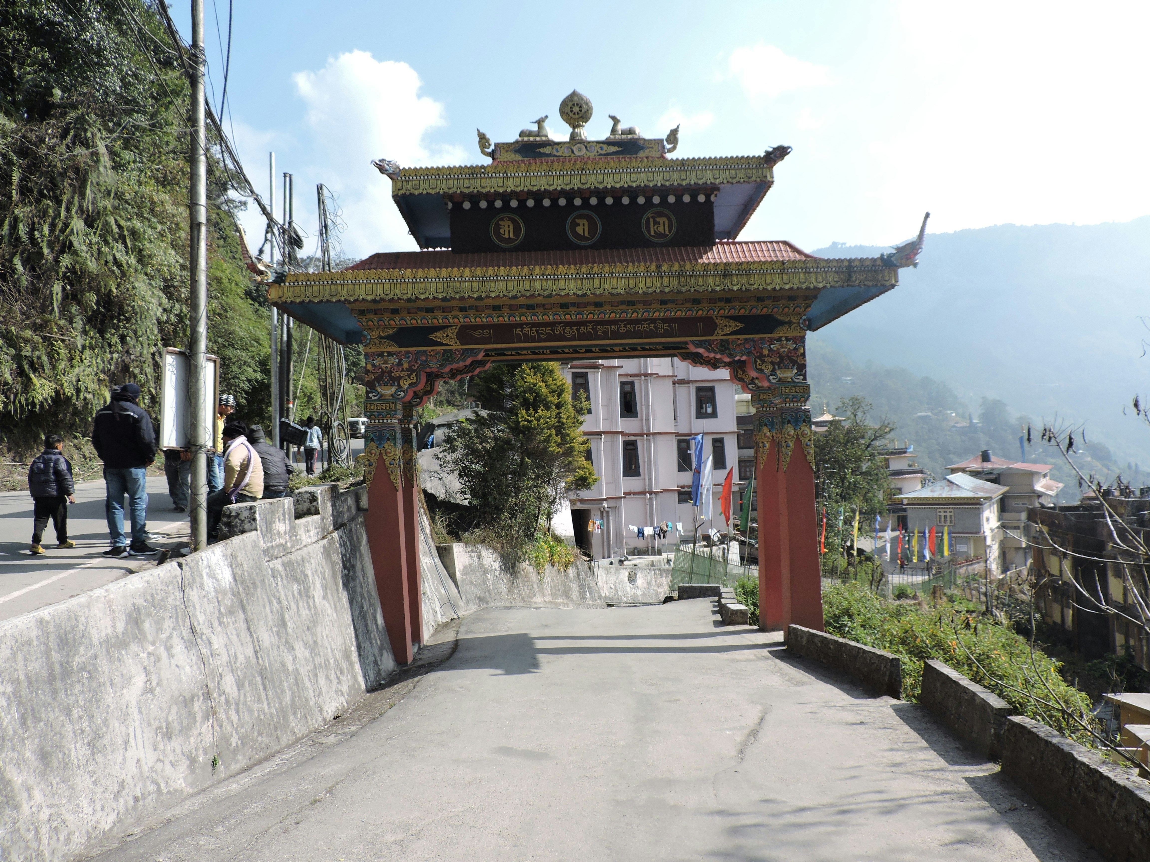 Gateway of Stone and Sky: Ornate Arch Framing a Mountain Town Street